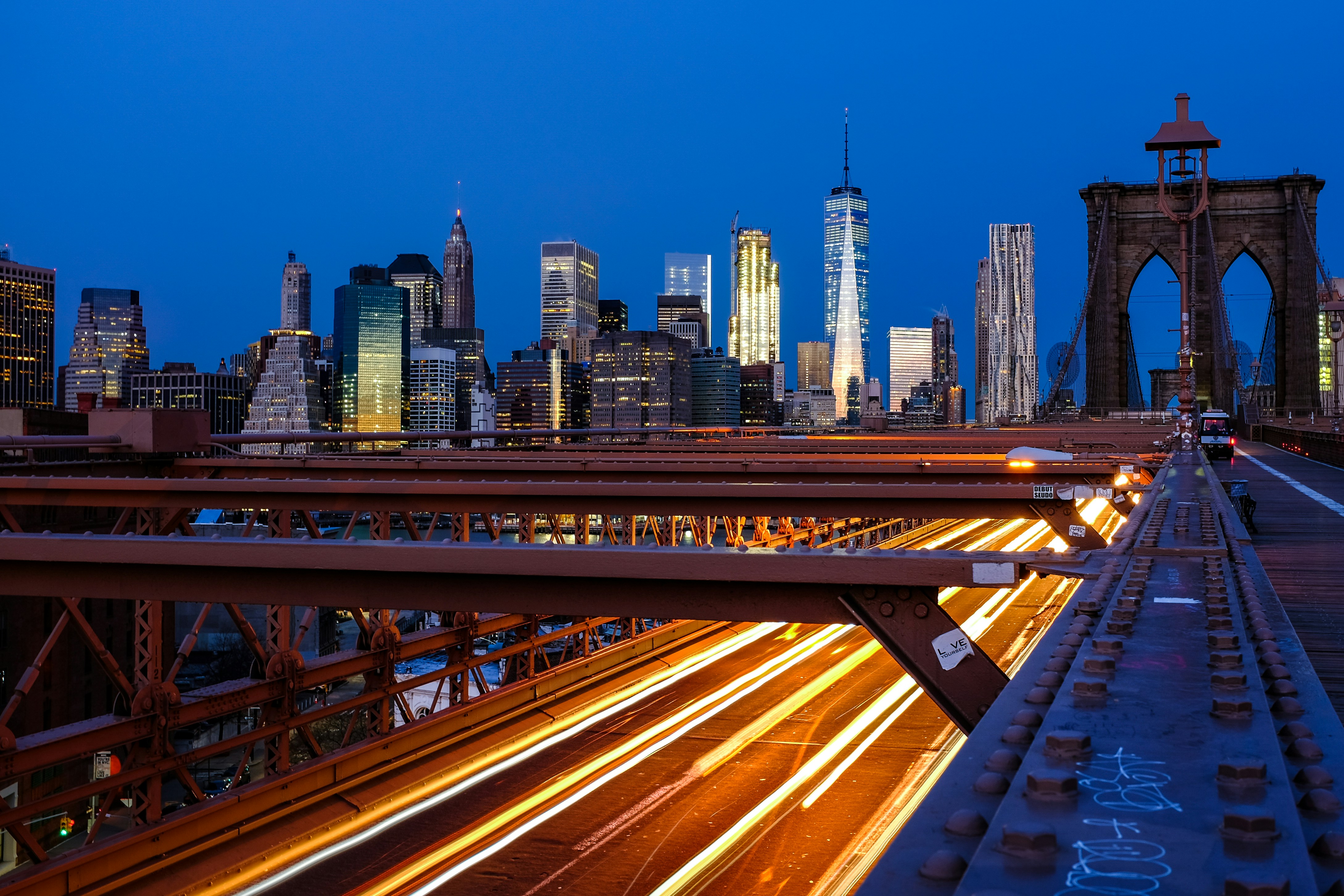 Brown wooden bridge over city skyline during night time photo – Free ...