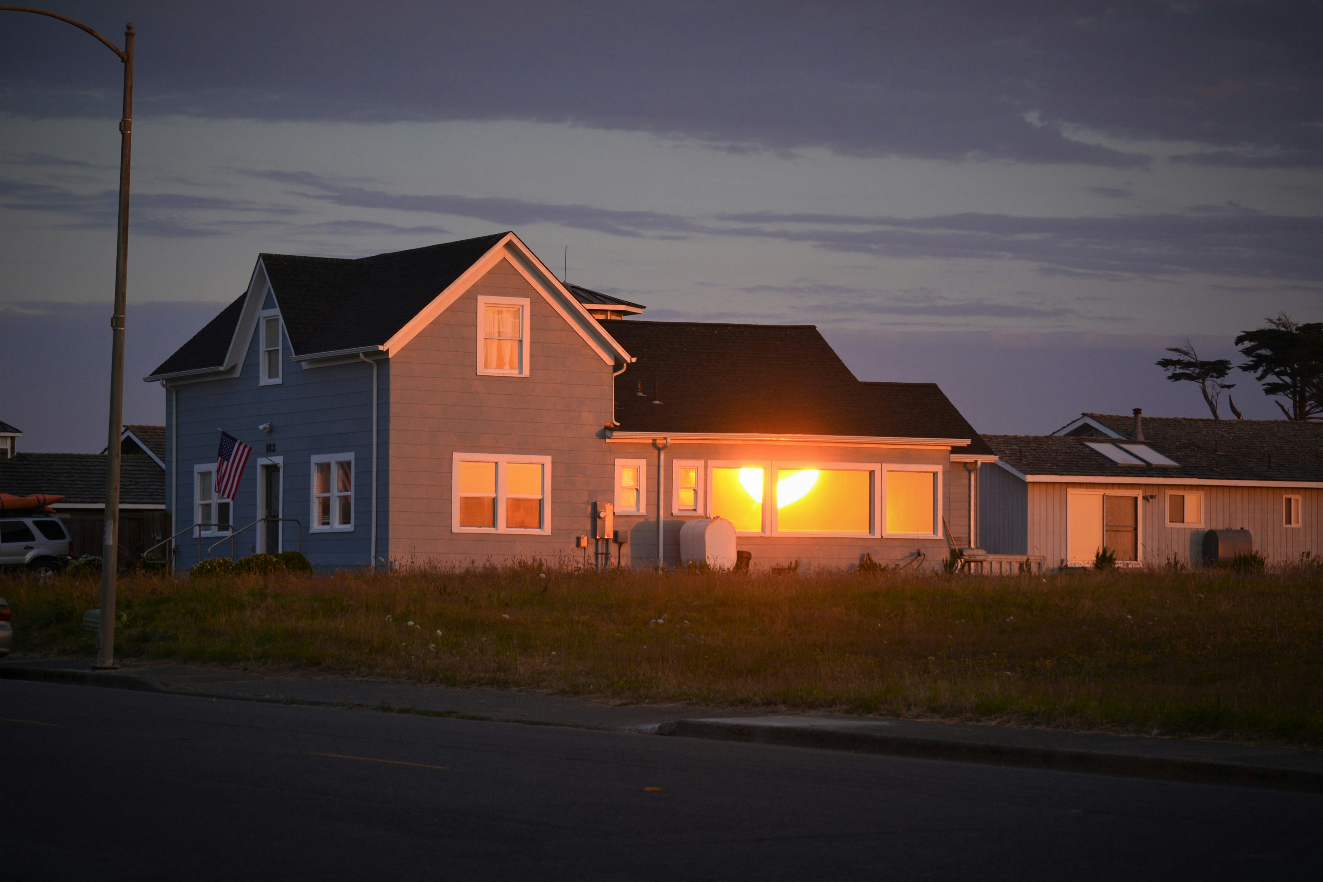 Sunlit Gable: twilight glow on coastal suburb