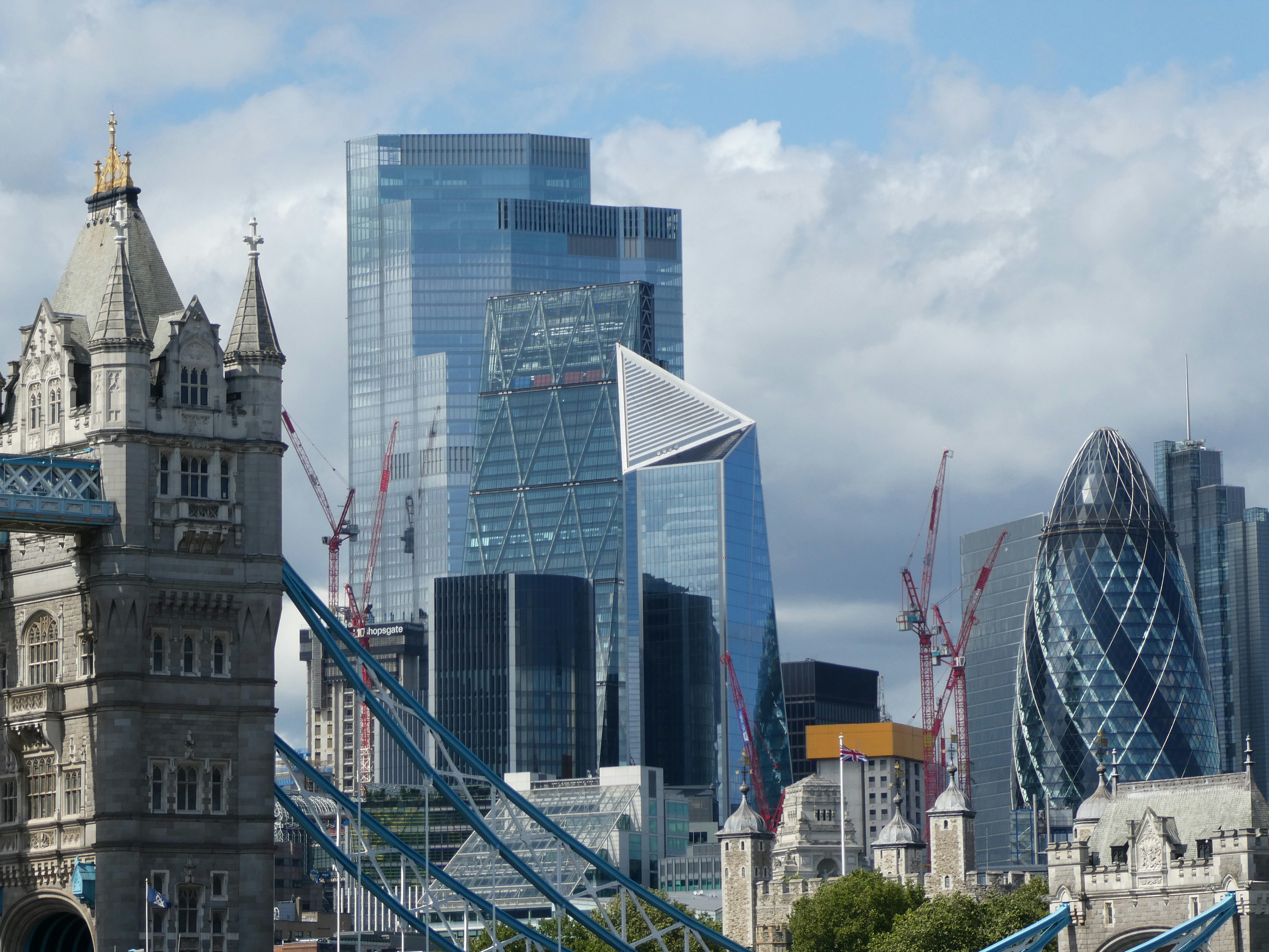 Towering Glass and Stone: A London-esque Skyline Over the Thames-like Bridge