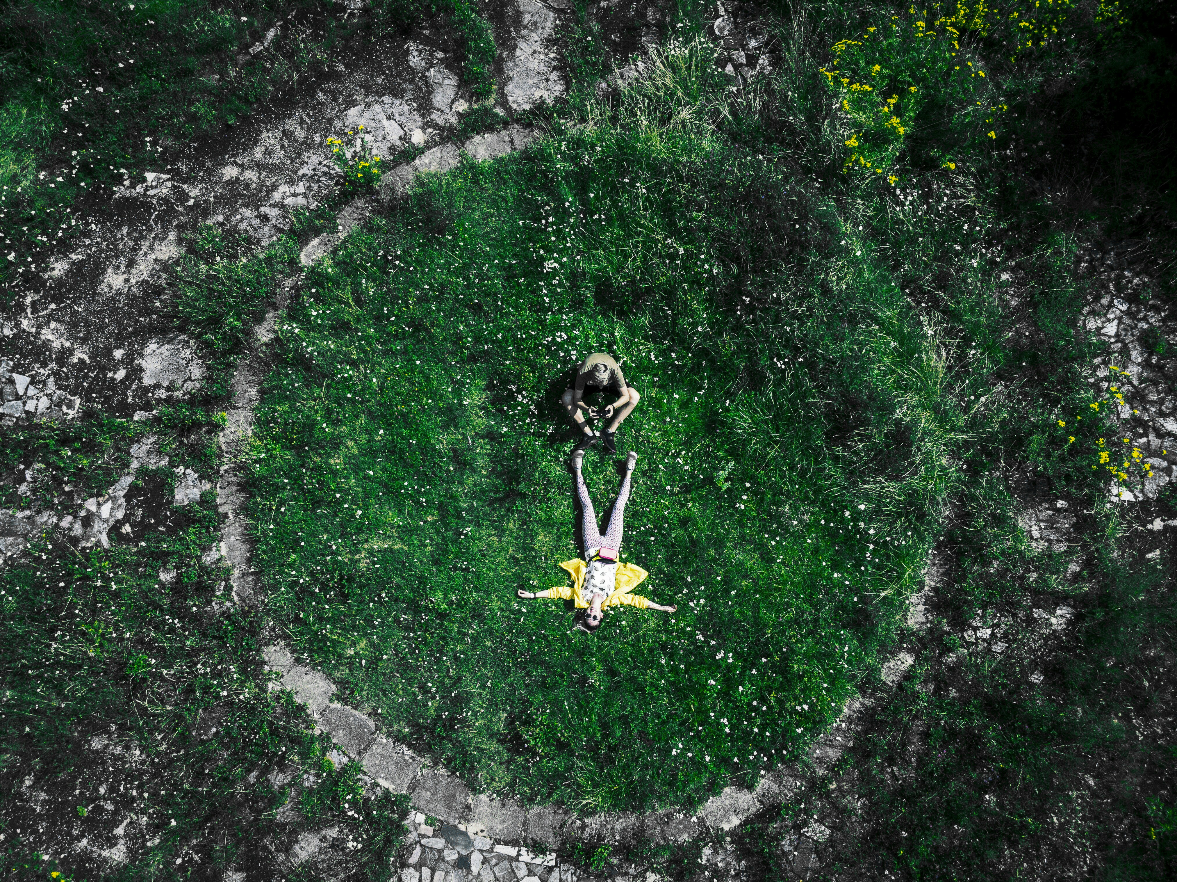 woman in yellow dress walking on green grass field during daytime