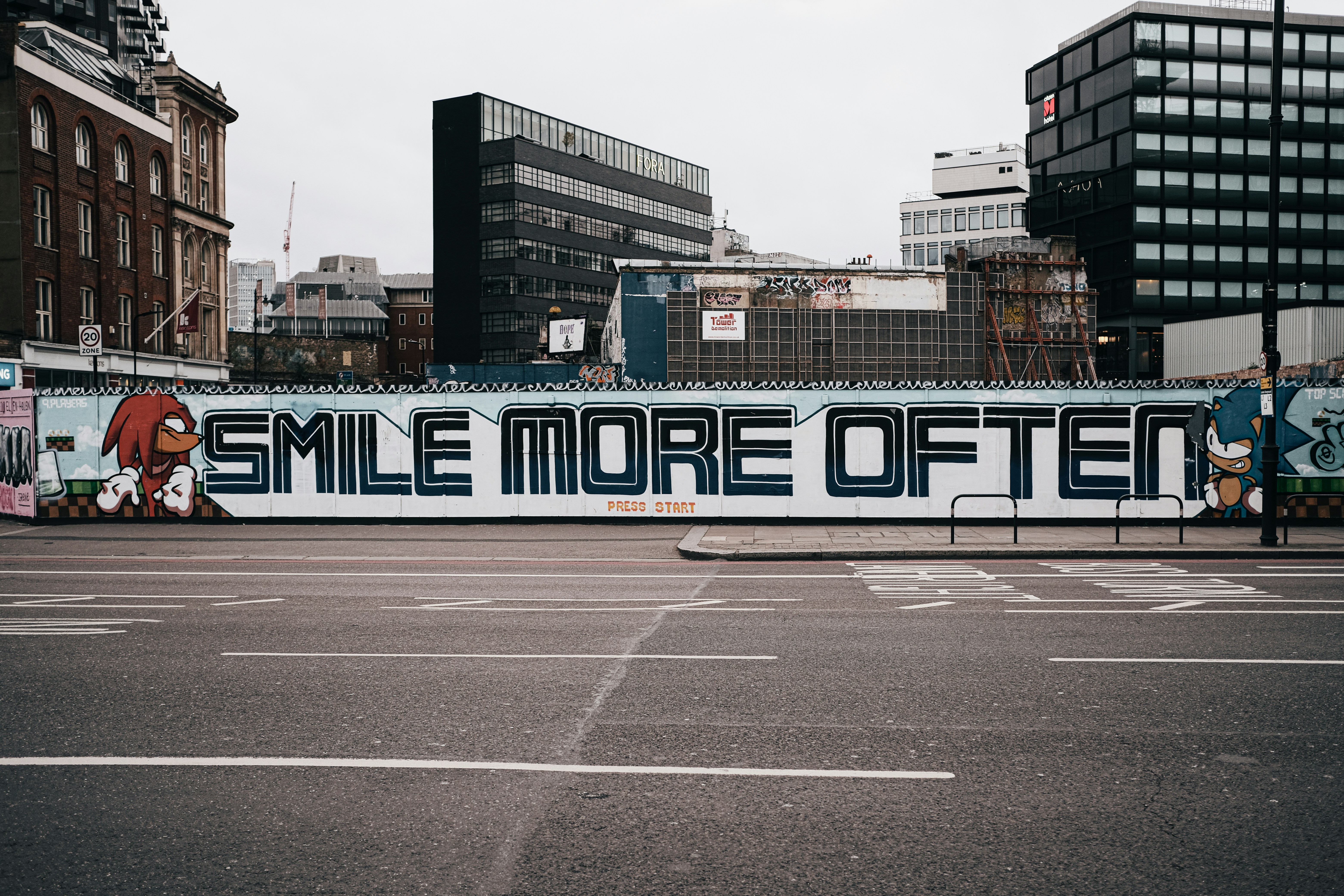 Urban Banner: Smile More Often Graffiti Across a Cityscape