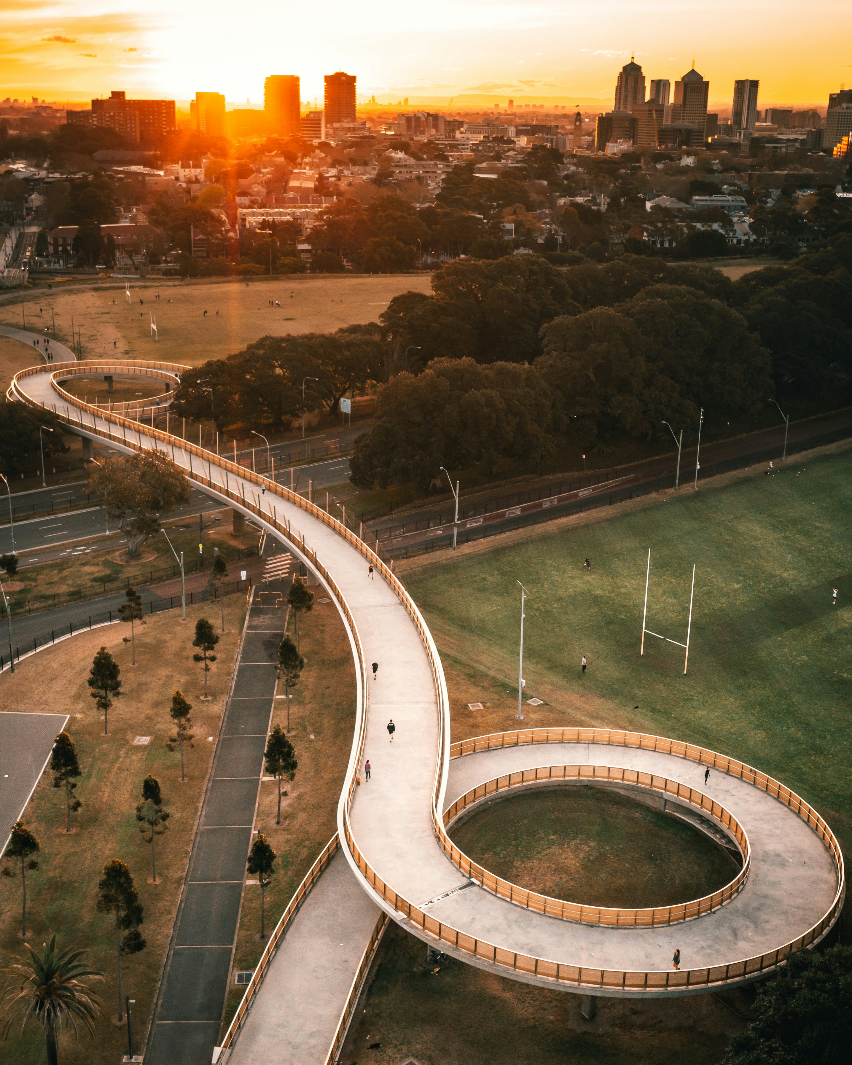 Sunset over the Serpentine Skywalk: Aerial Portrait of a City Park