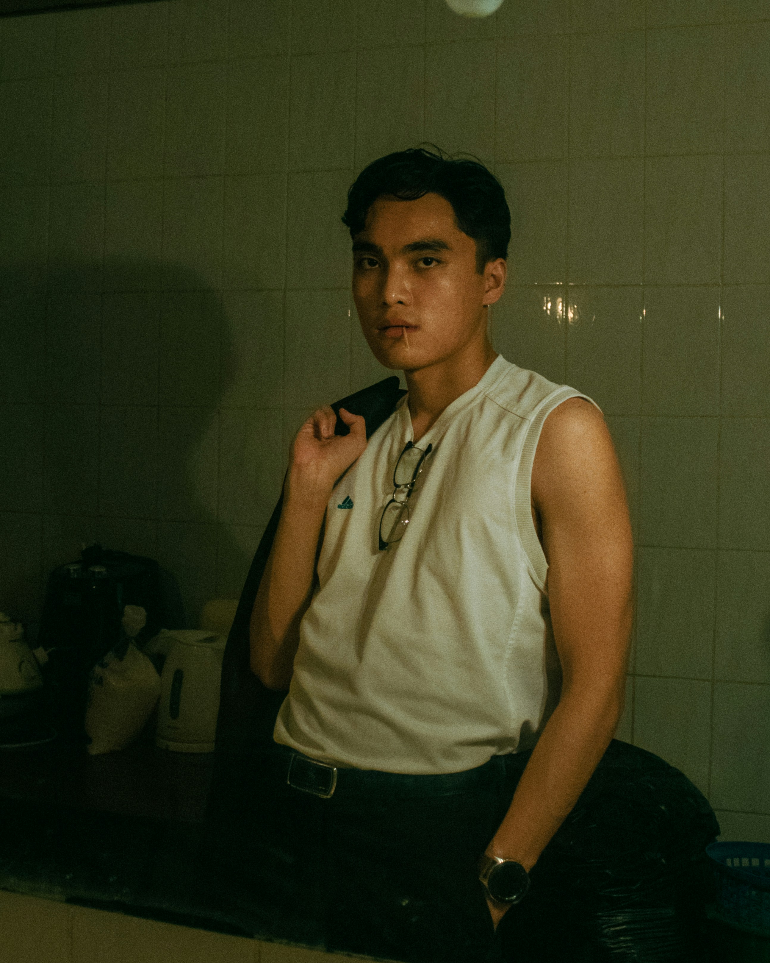 Dim Kitchen Portrait: A Quiet, Focused Moment with a Sleeveless White Tee