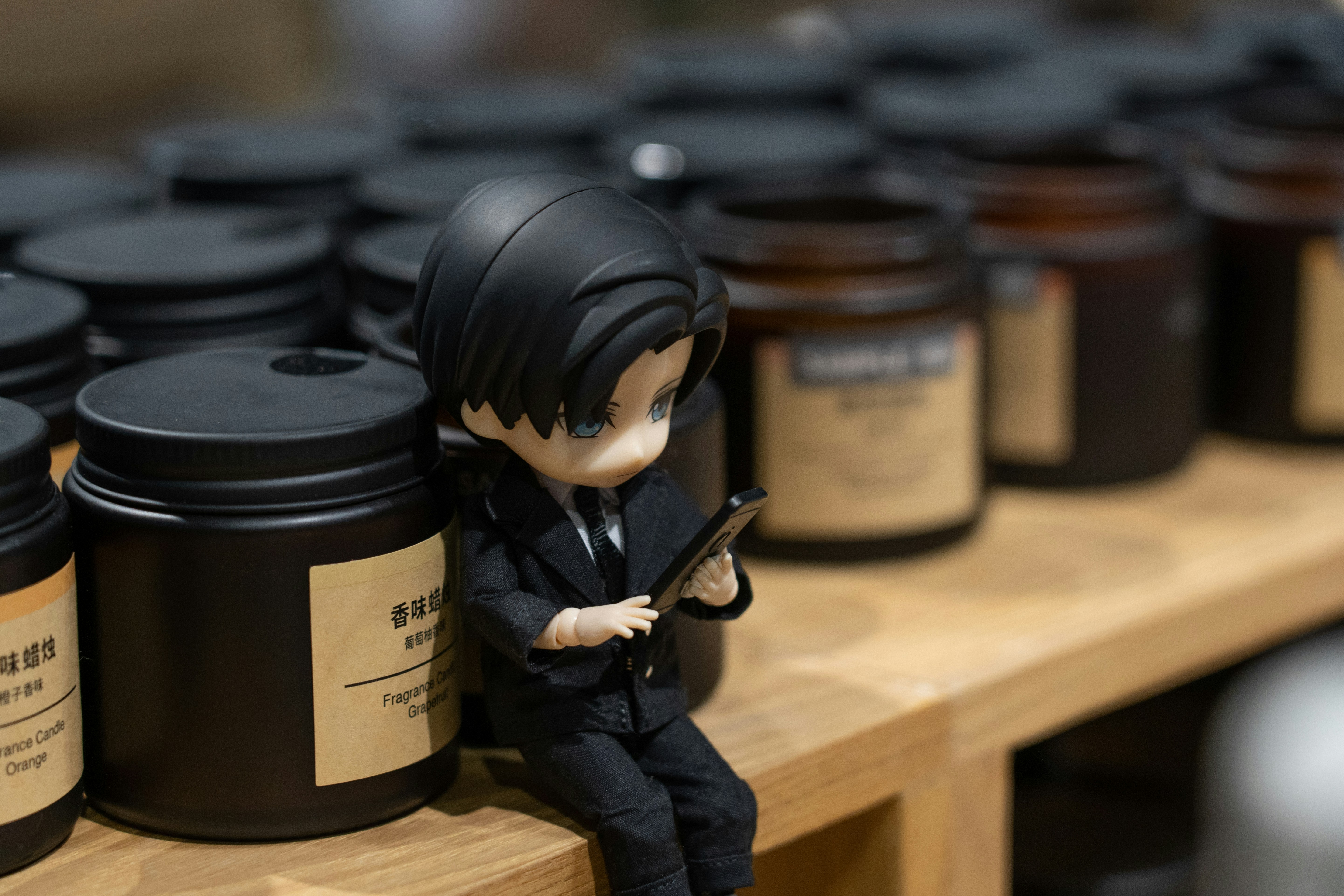 Tiny Stylist: A Miniature Photographer Comes to Life Among Inkwell Jars