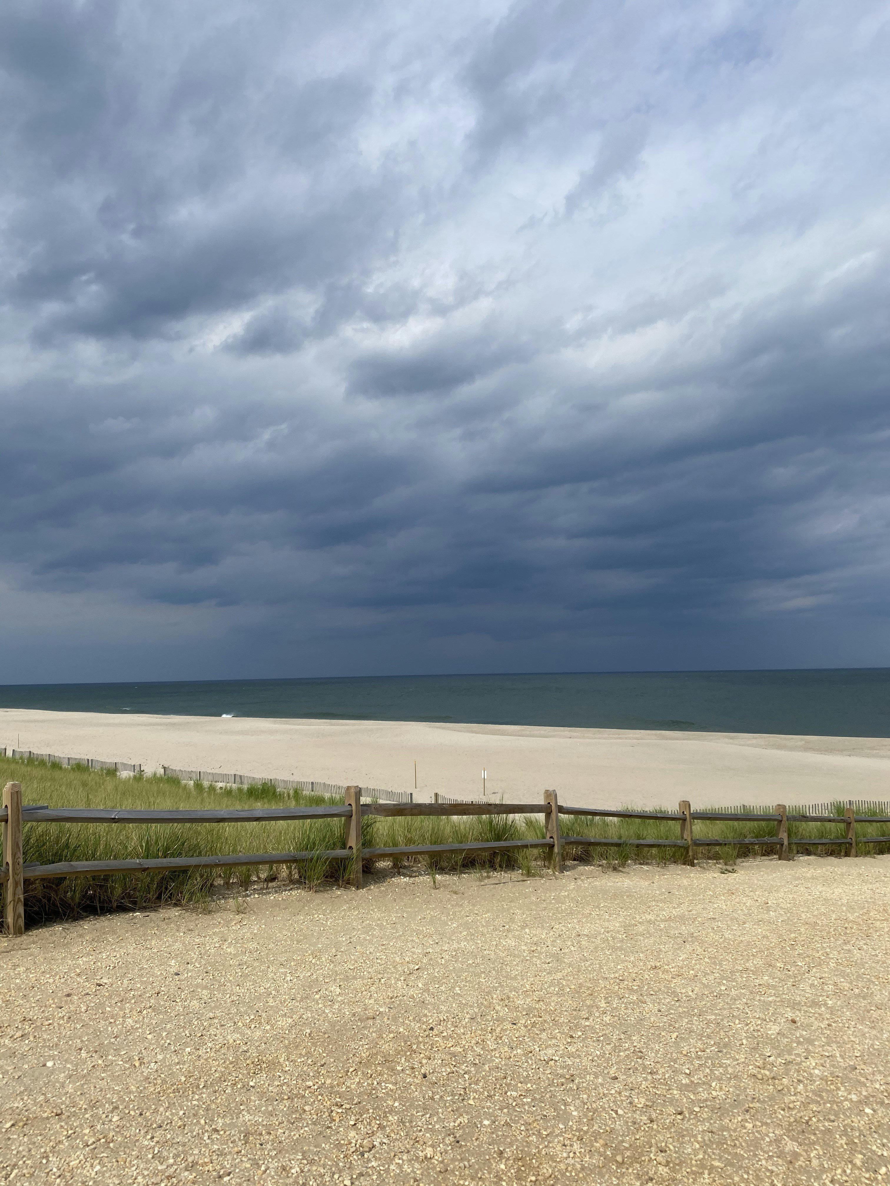 Storm-Washed Horizon: A Quiet Beach Under Cloudy Skies
