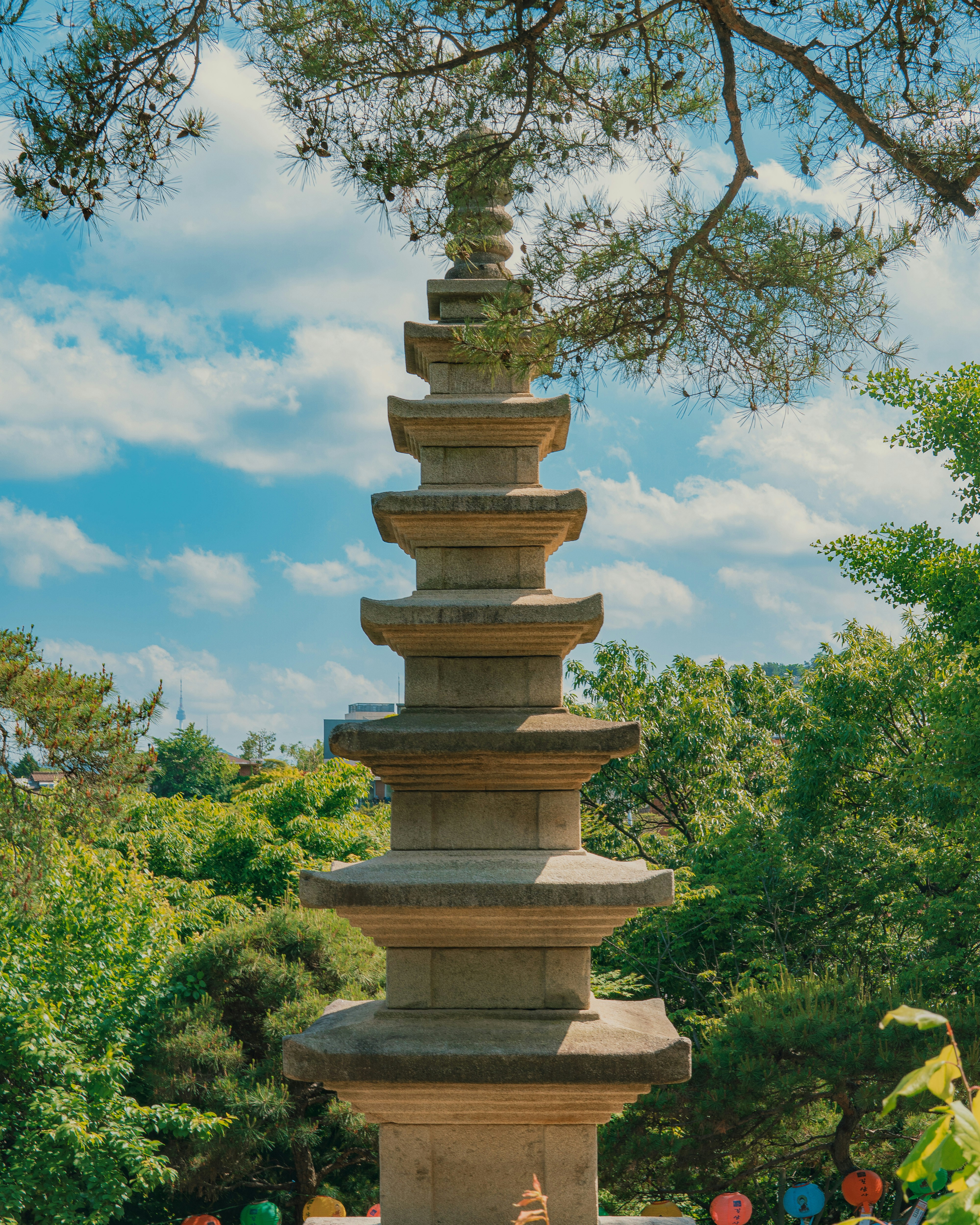 Stone Pagoda in a Lush Garden under a Bright Sky