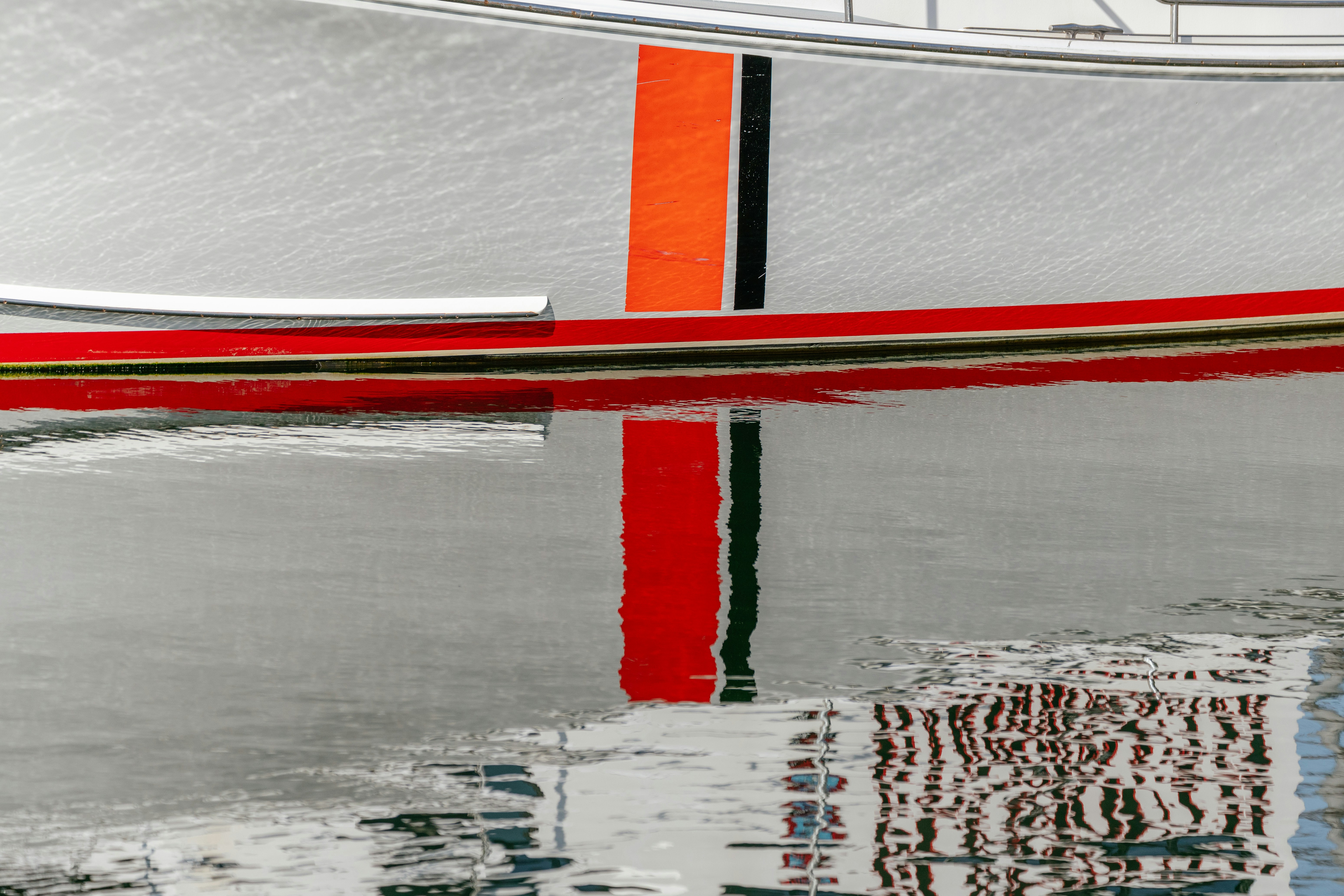 Red and white metal bar on water photo – Free Boat Image on Unsplash