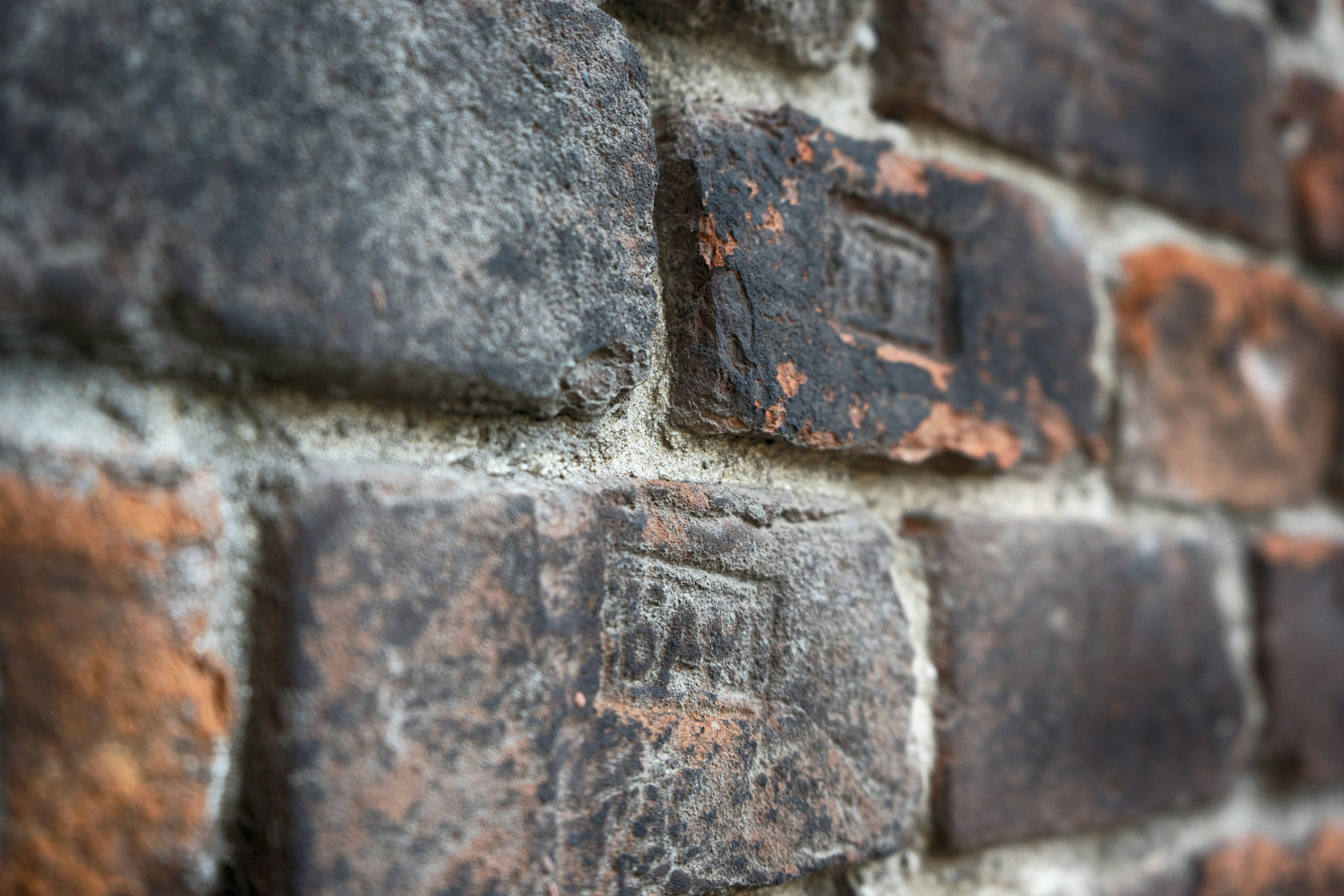 Brickwork Echoes: A Weathered Stamp in the Old Wall