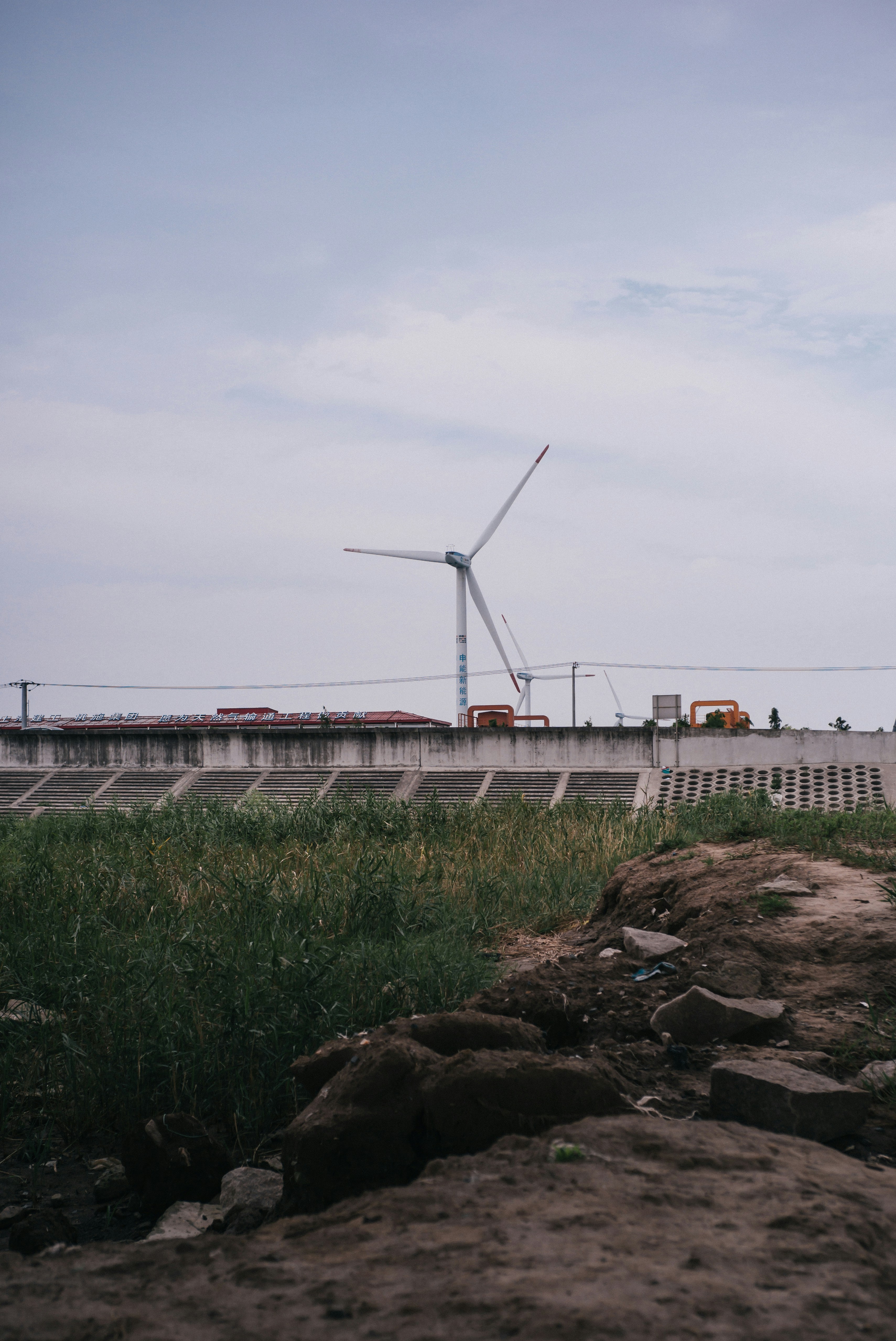 wind mill on rocky shore during daytime