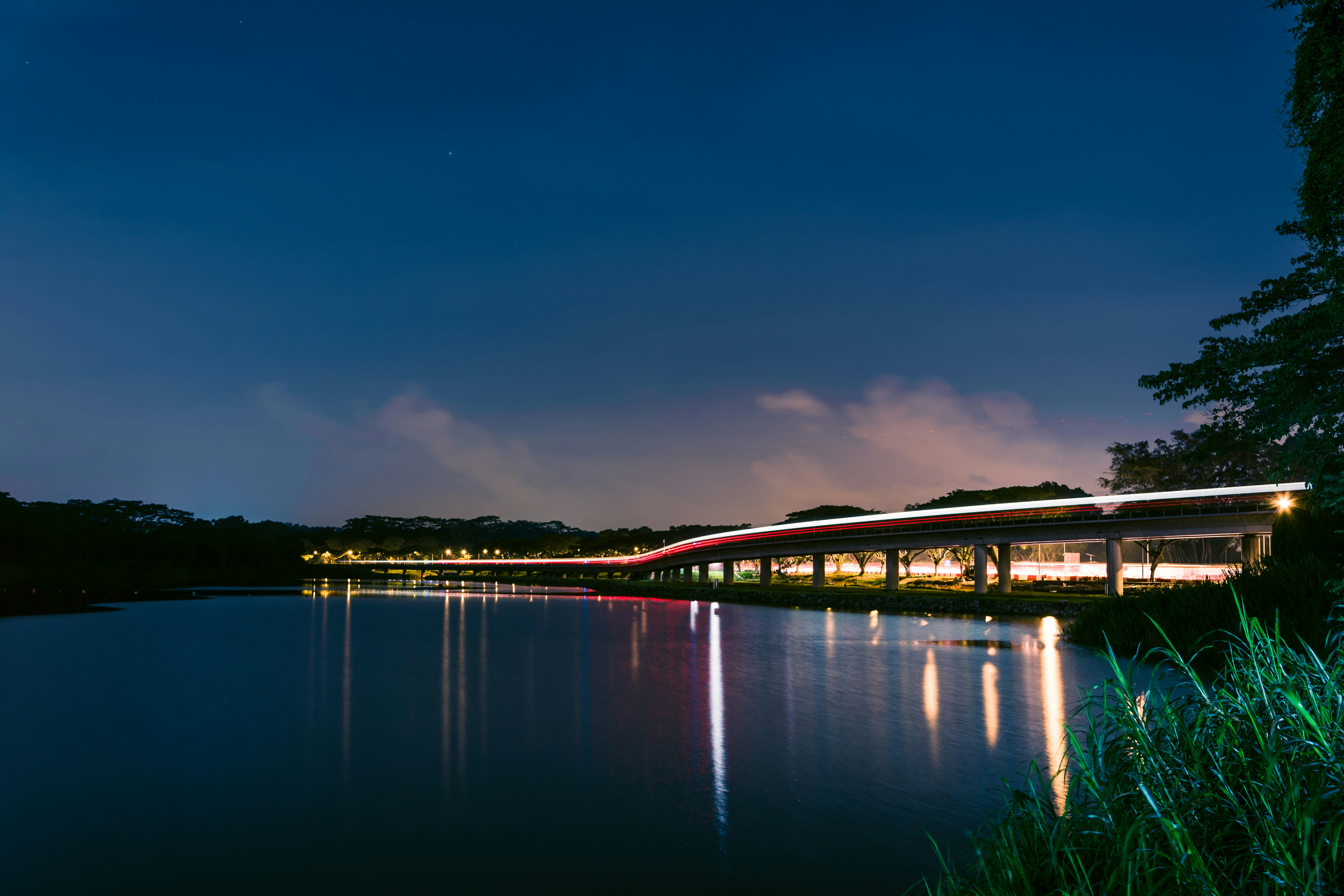 Brown bridge over water during night time photo – Free Beach Image on ...