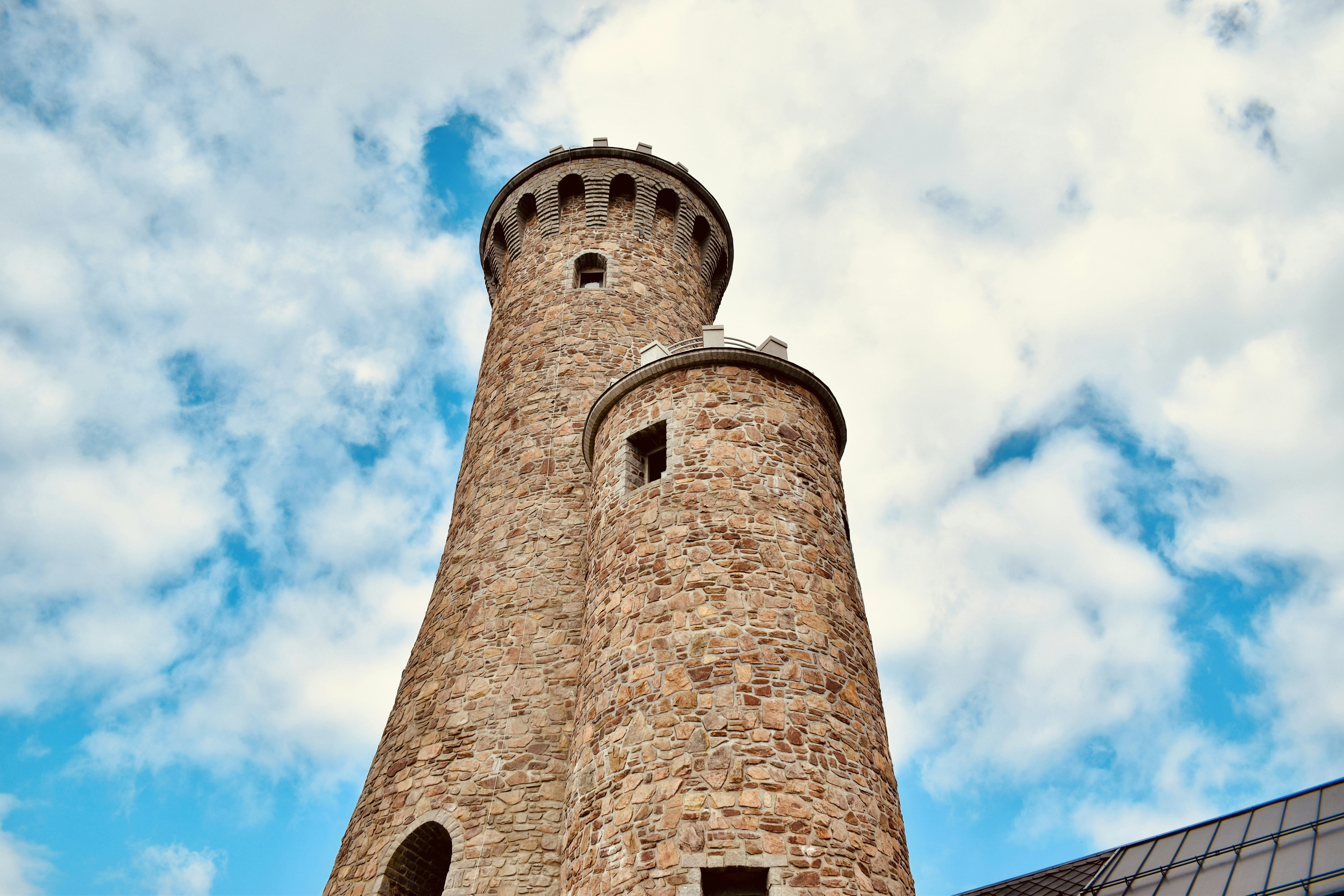 Brown concrete tower under blue sky and white clouds during daytime ...