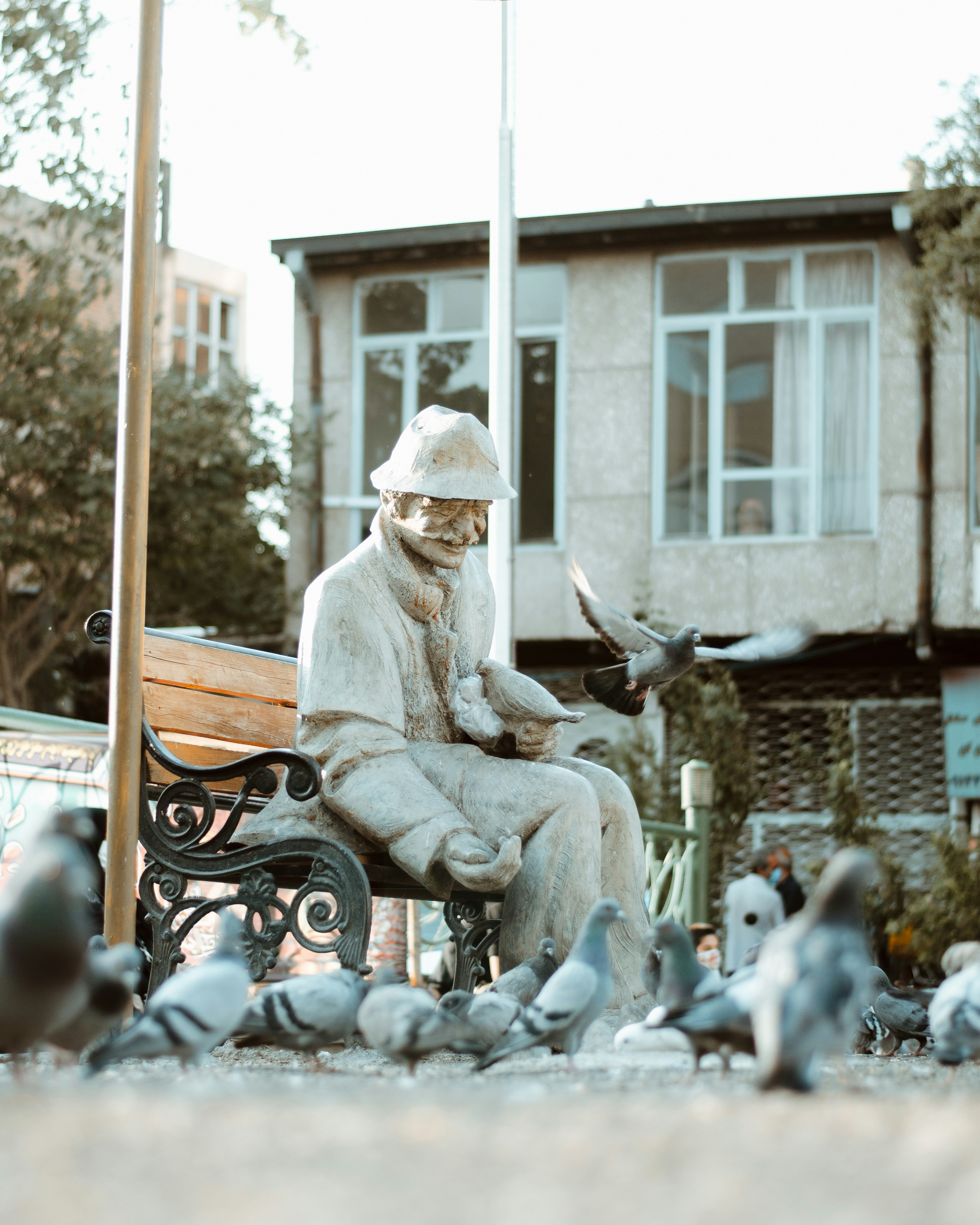 man in brown jacket sitting on bench