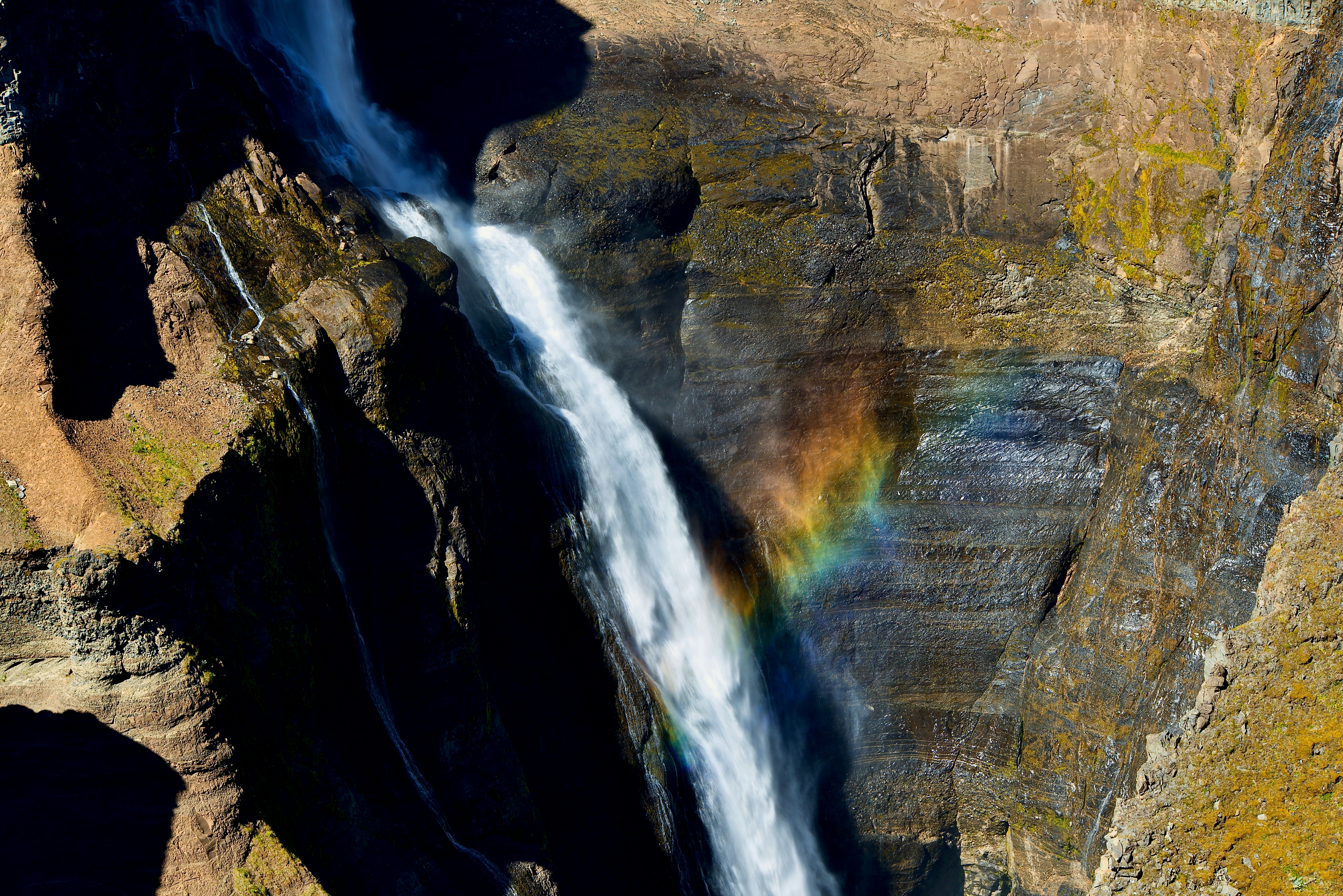 Cascade's Prism: Nature's Palette on Rocky Canvas