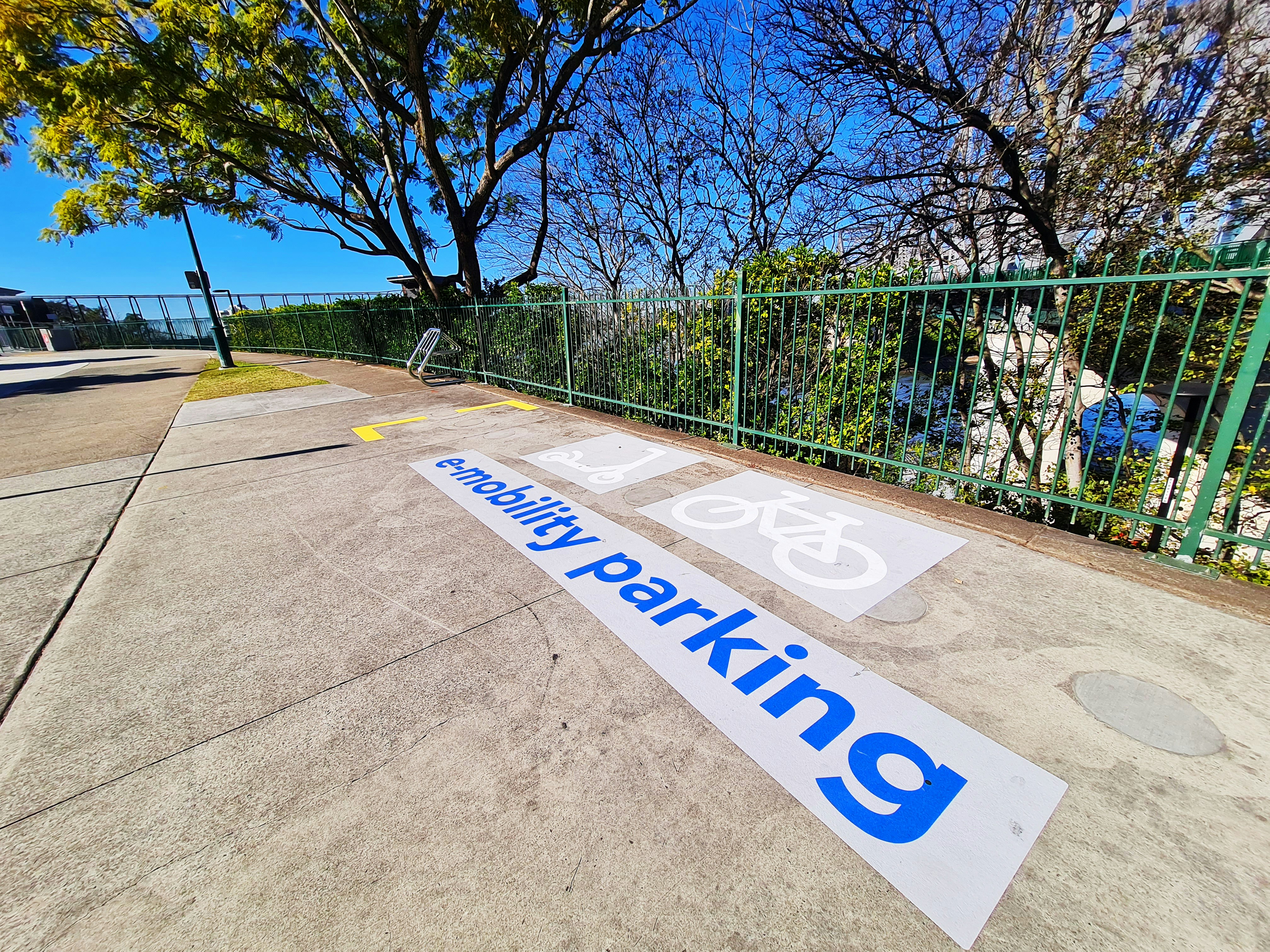 Emobility parking sign on footpath in Brisbane, Australia. Waiting for ebikes. | blue and white road sign