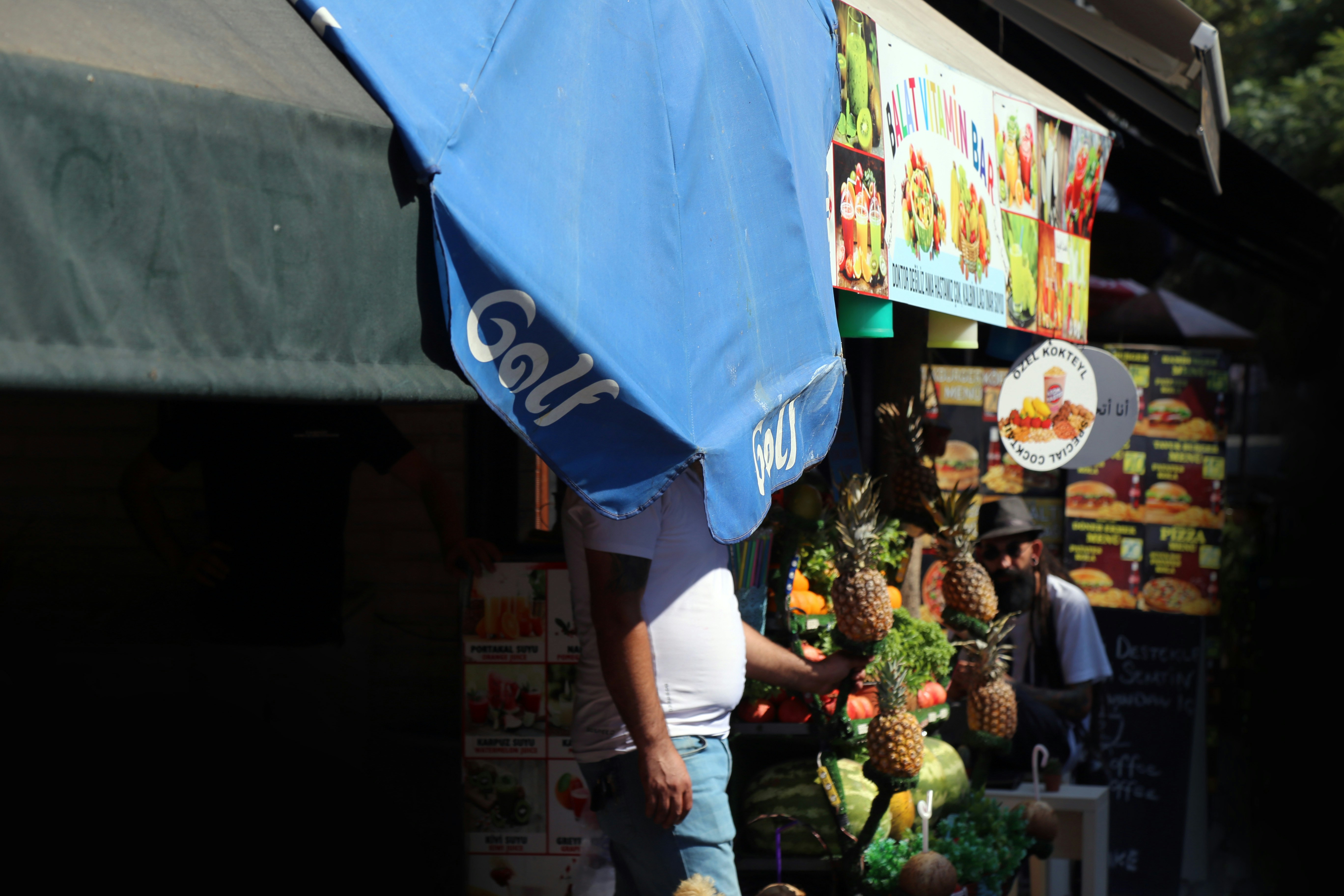 Pineapple Parade under a Blue Market Canopy