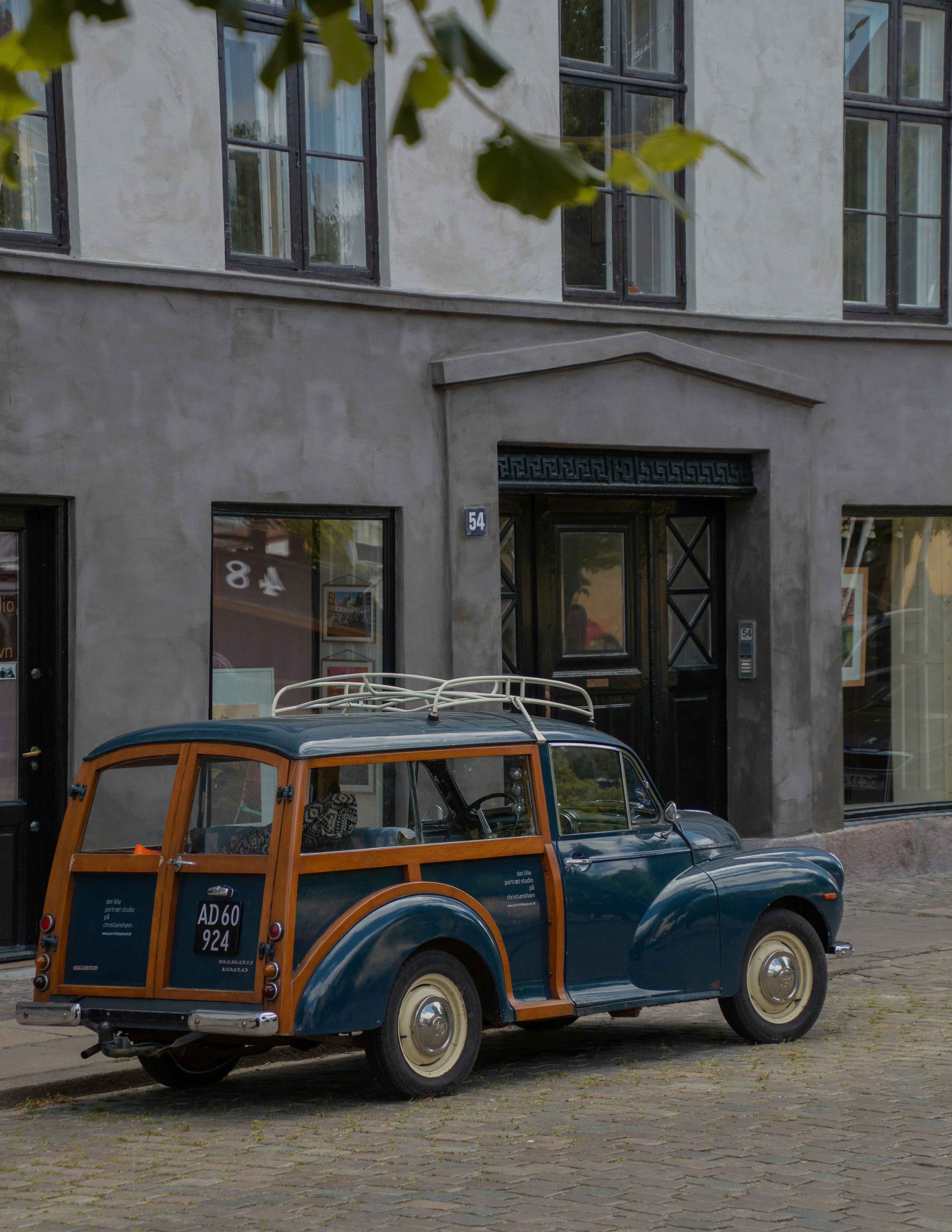 Azure Classic: A vintage van rests on cobblestones in muted city tones