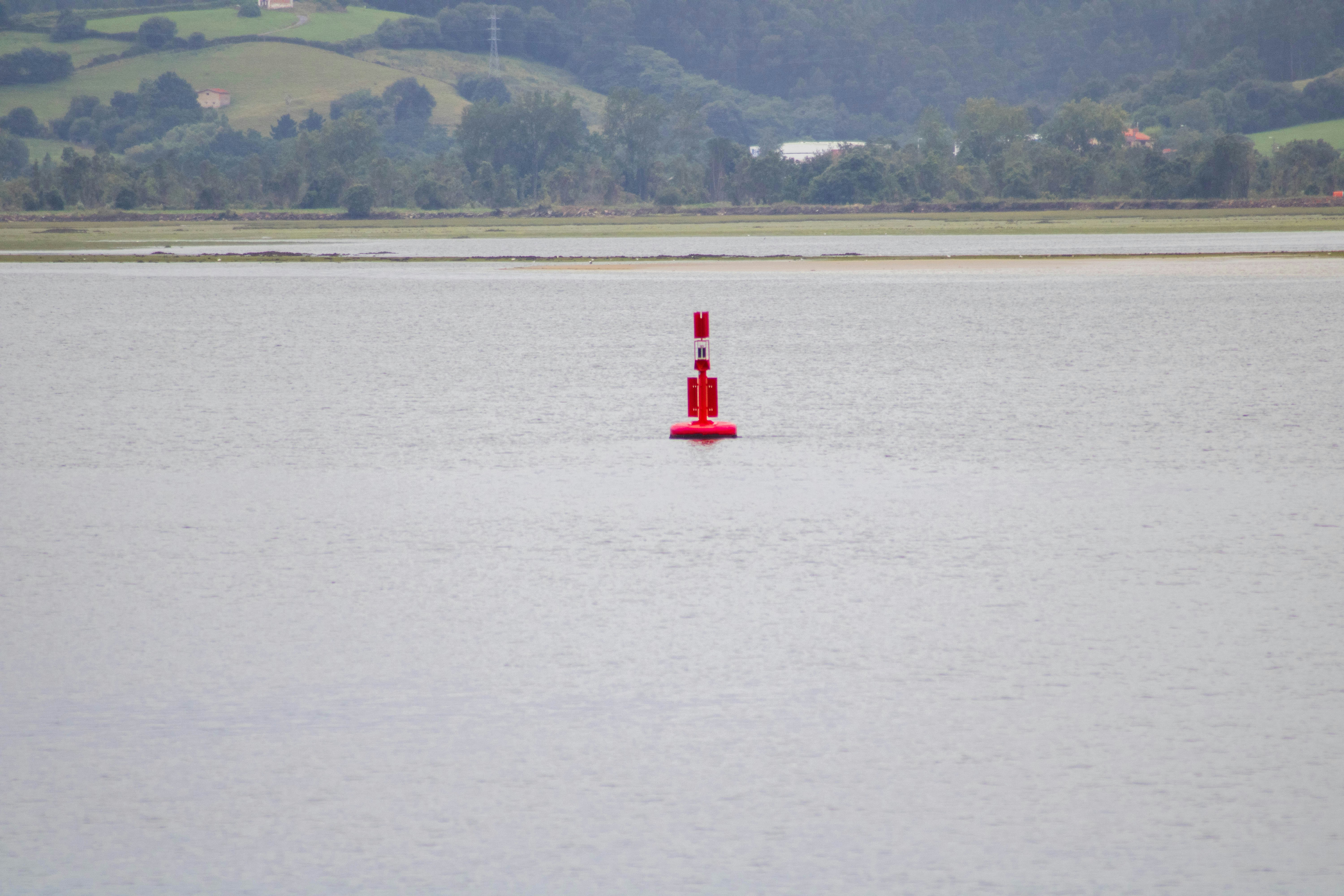 red and white boat on sea during daytime