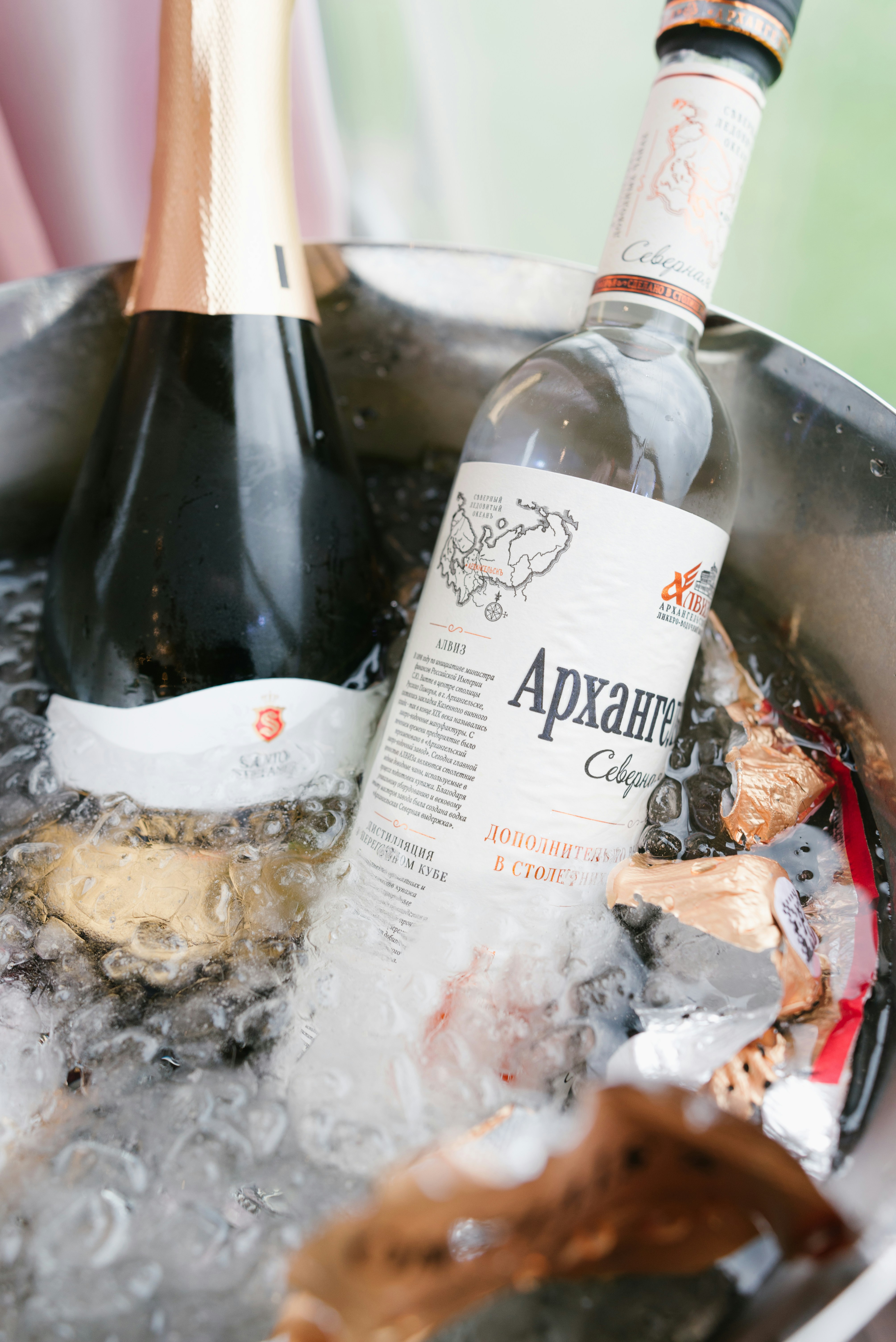 Chilled Cyrillic: A Cyrillic-label wine bottle cooling in a gleaming ice bucket