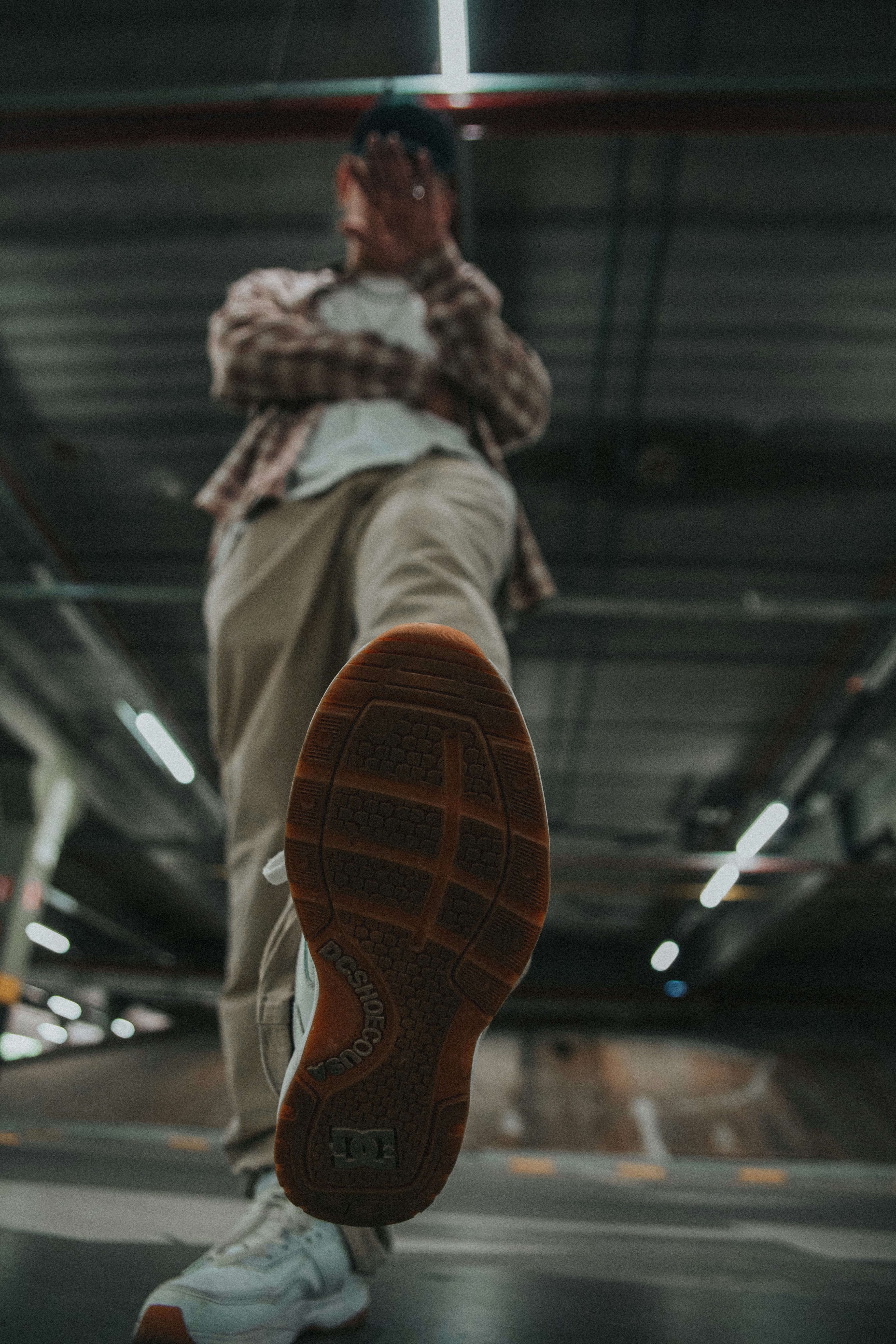 Sole Focus: A Low-Angle Moment in a Dim Parking Garage