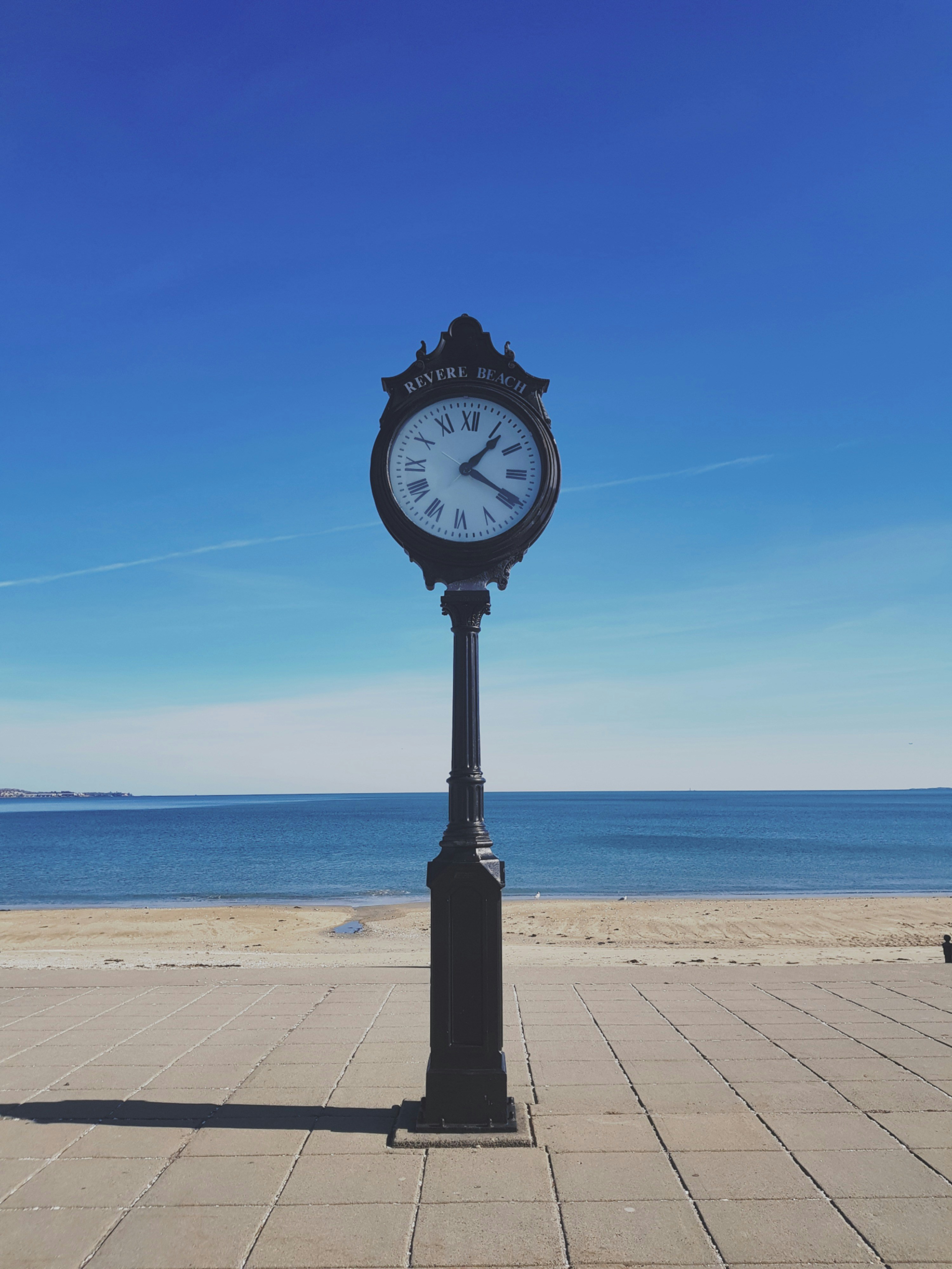 Coastal Clockkeeper on a Sunlit Promenade