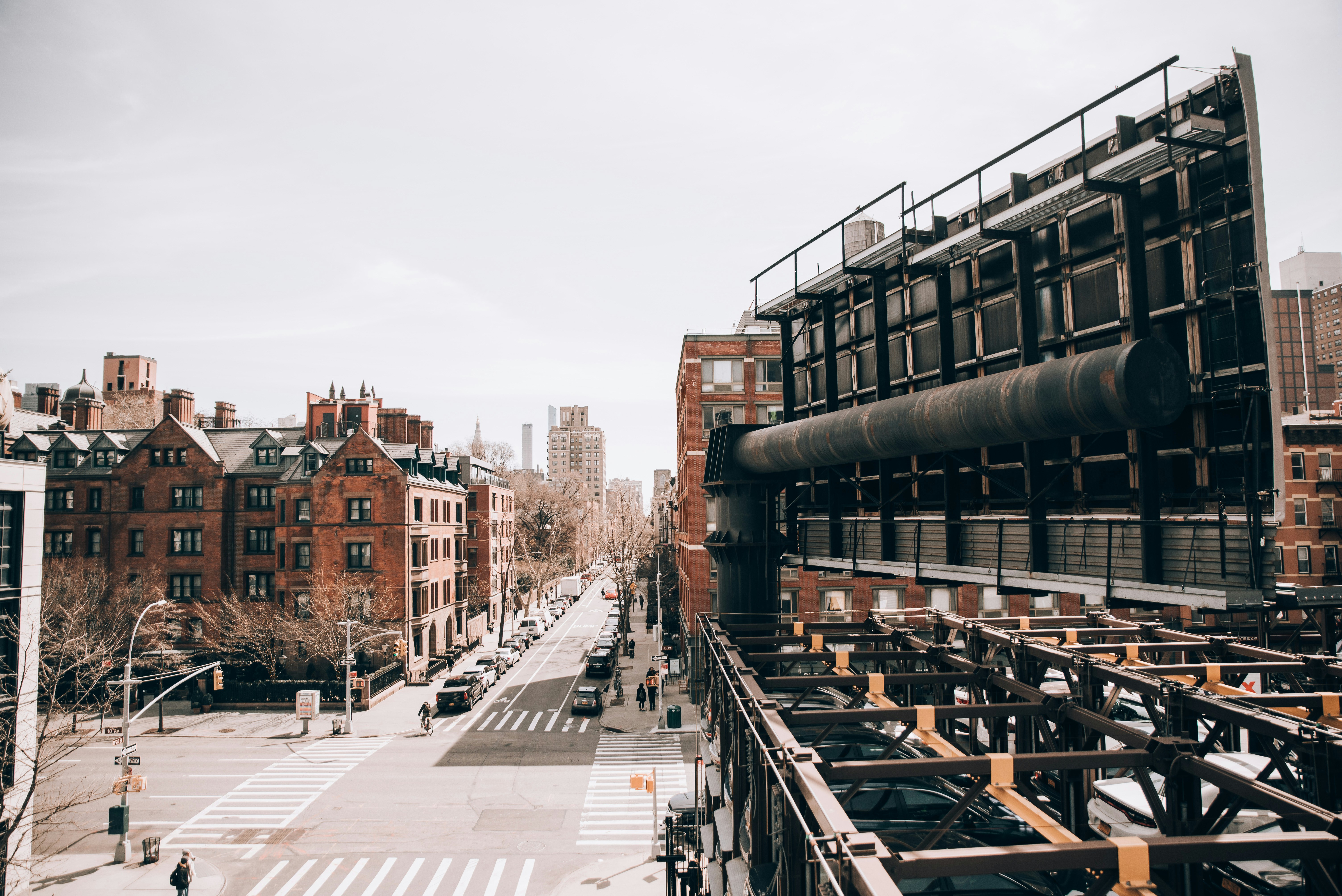 Steel Beams Over a Quiet City Street: A Vanishing Perspective from a Rooftop Corridor