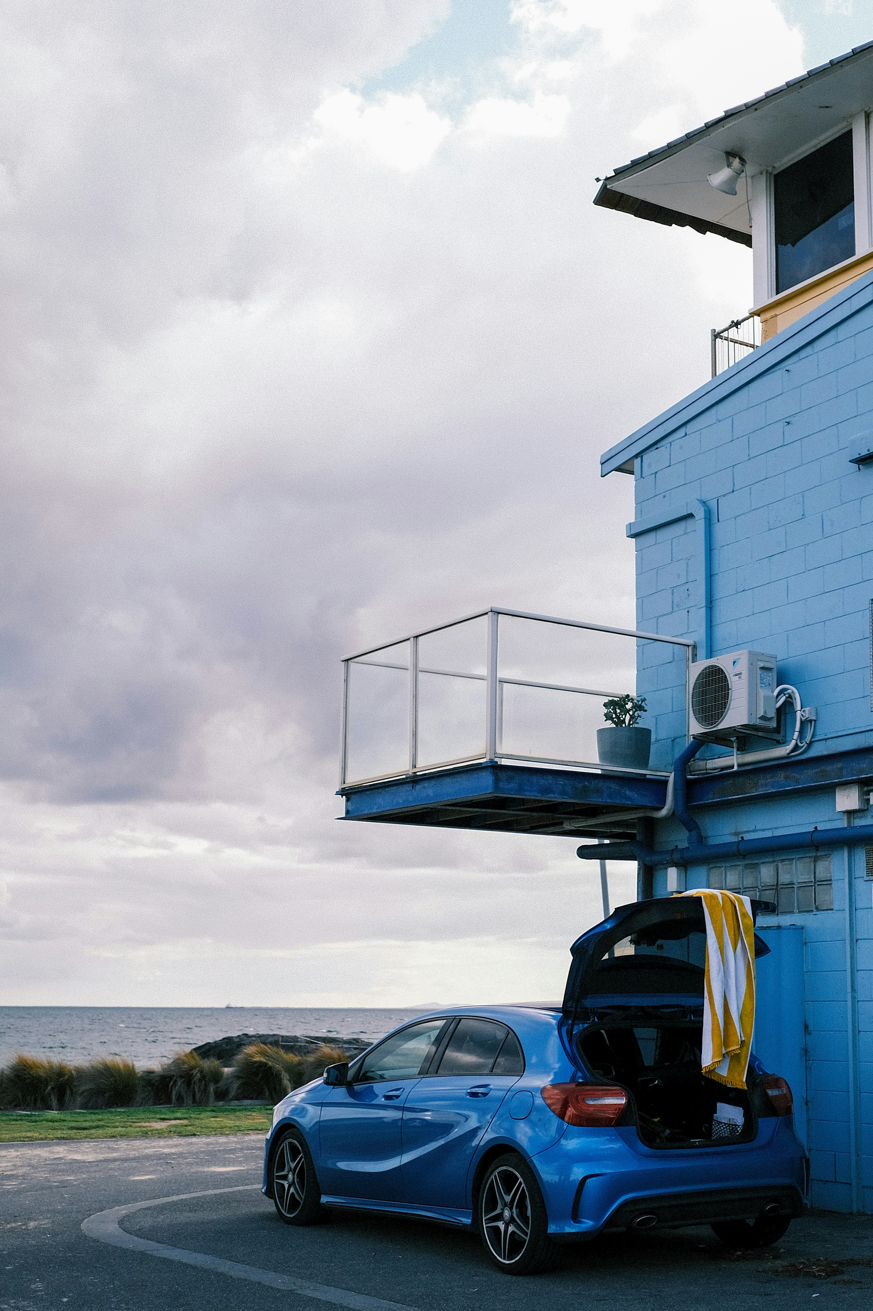 Coastal Blue Stop: A Compact Hatchback by a Seaside Loft