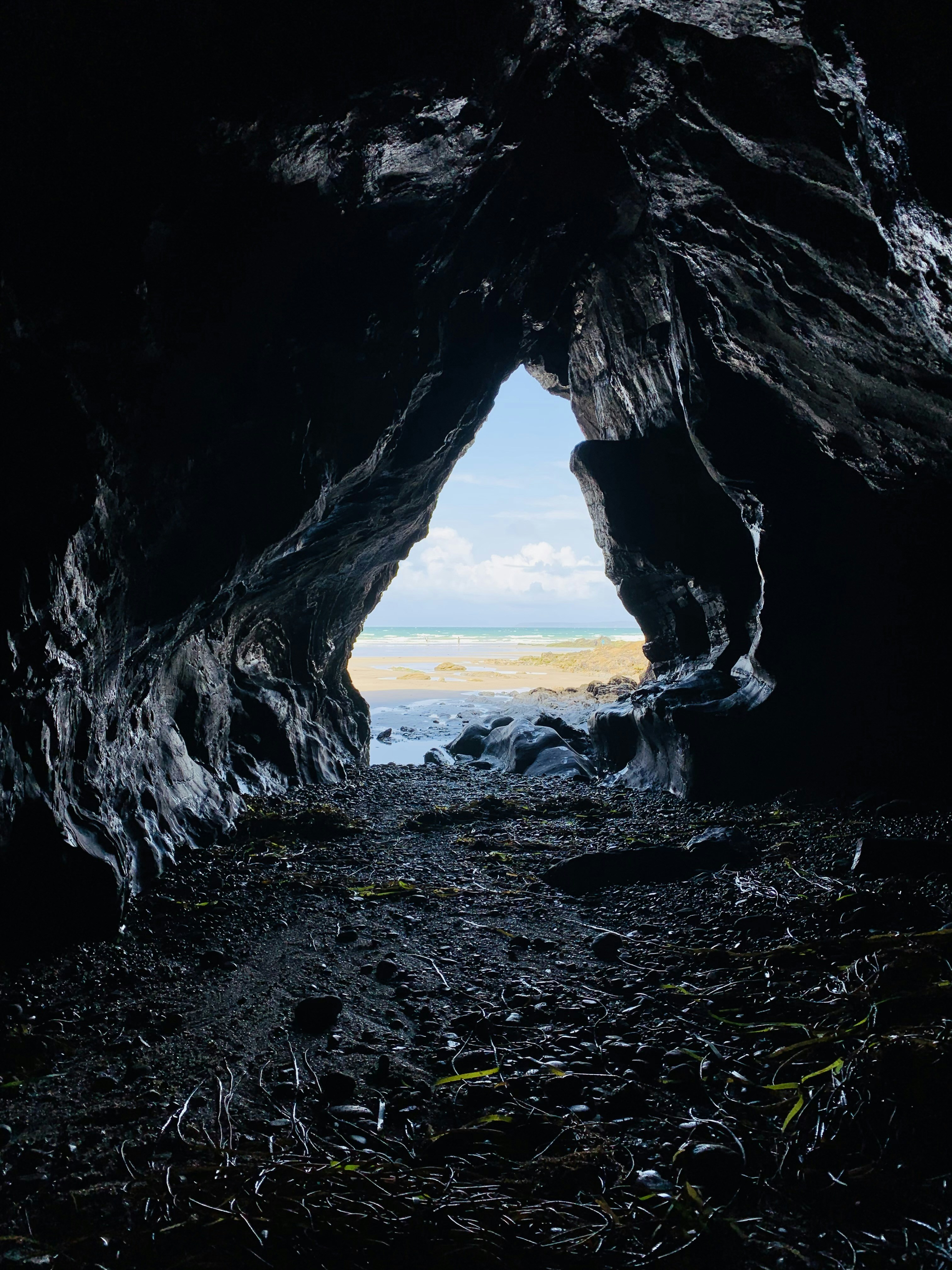 Black rock formation near body of water during daytime photo – Free ...