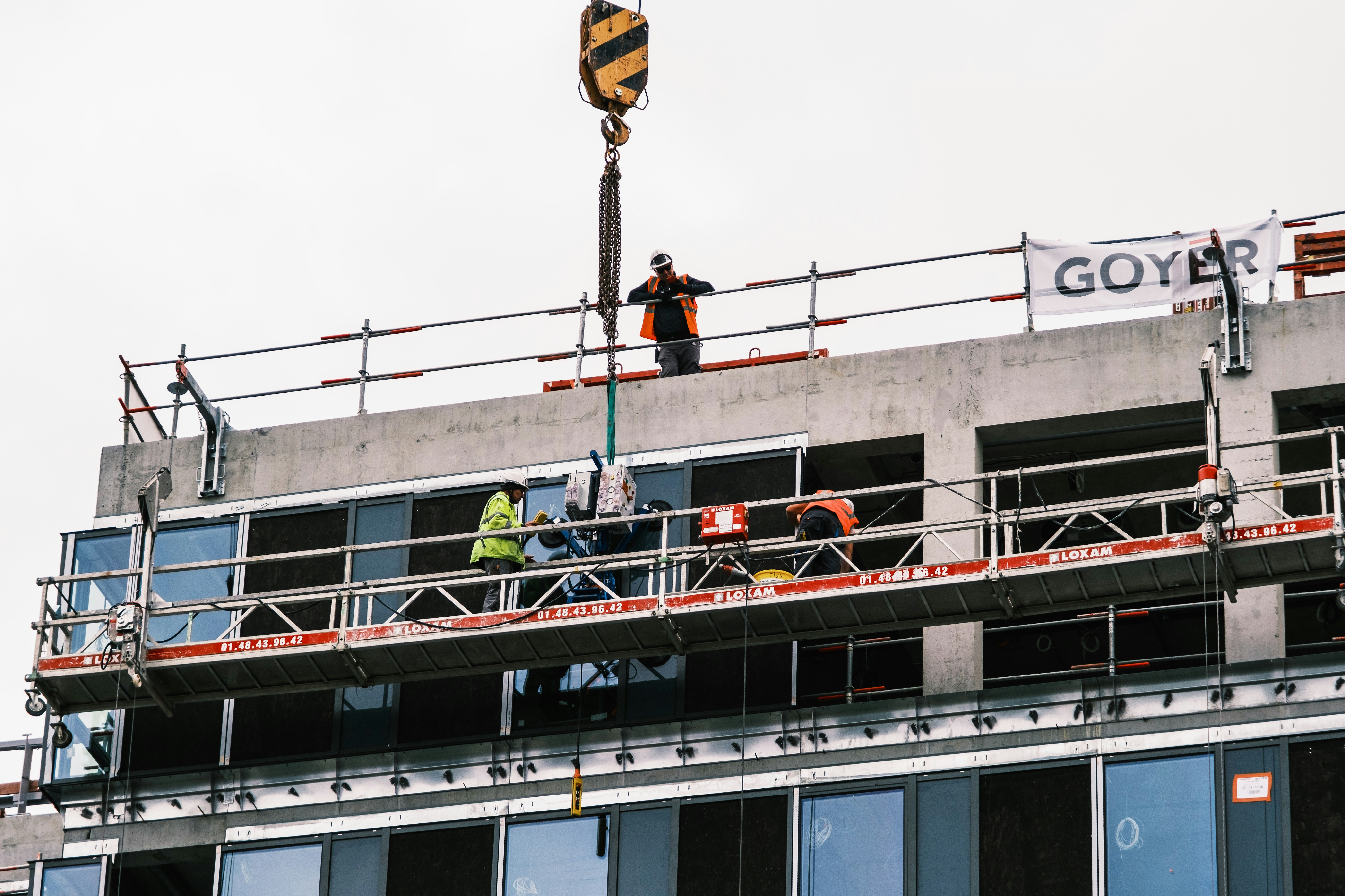 Risers, Rigging, and Resolve: Workers on a Partially Completed High-Rise