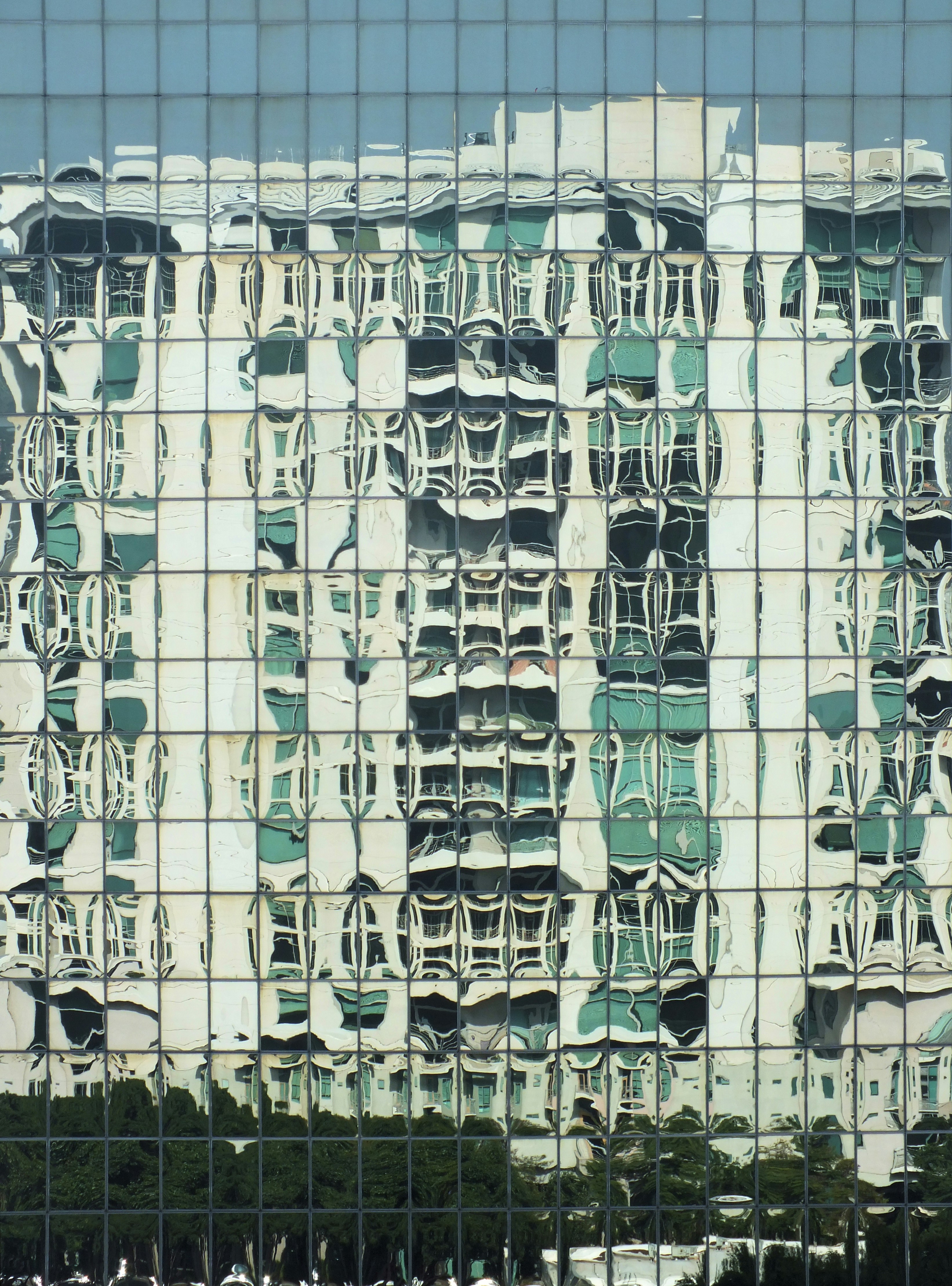 Warped Grid: Distorted Reflections on a Glass-Faced Tower