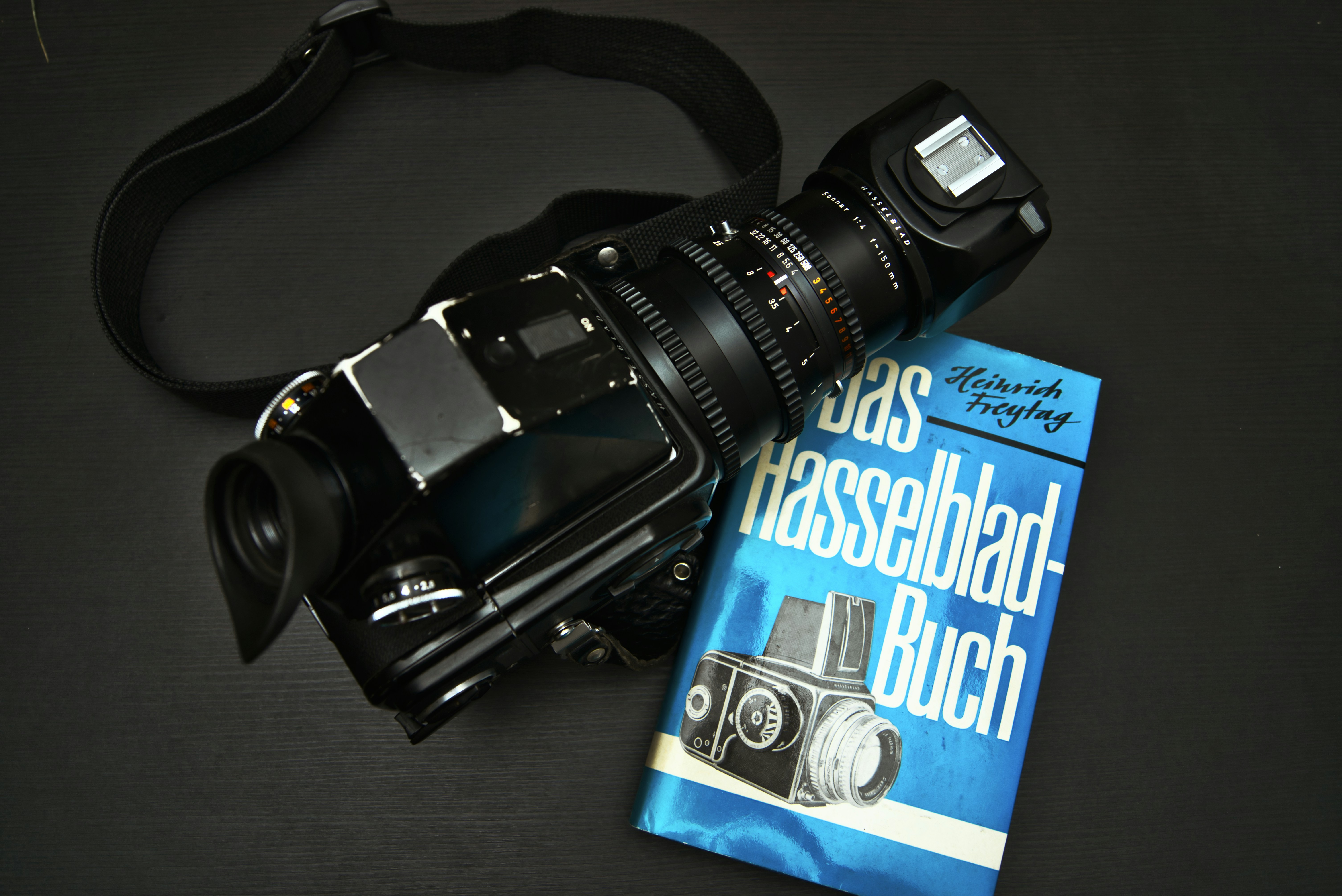 Diagonal Focus: A Sony A65 Beside a Hasselblad Book
