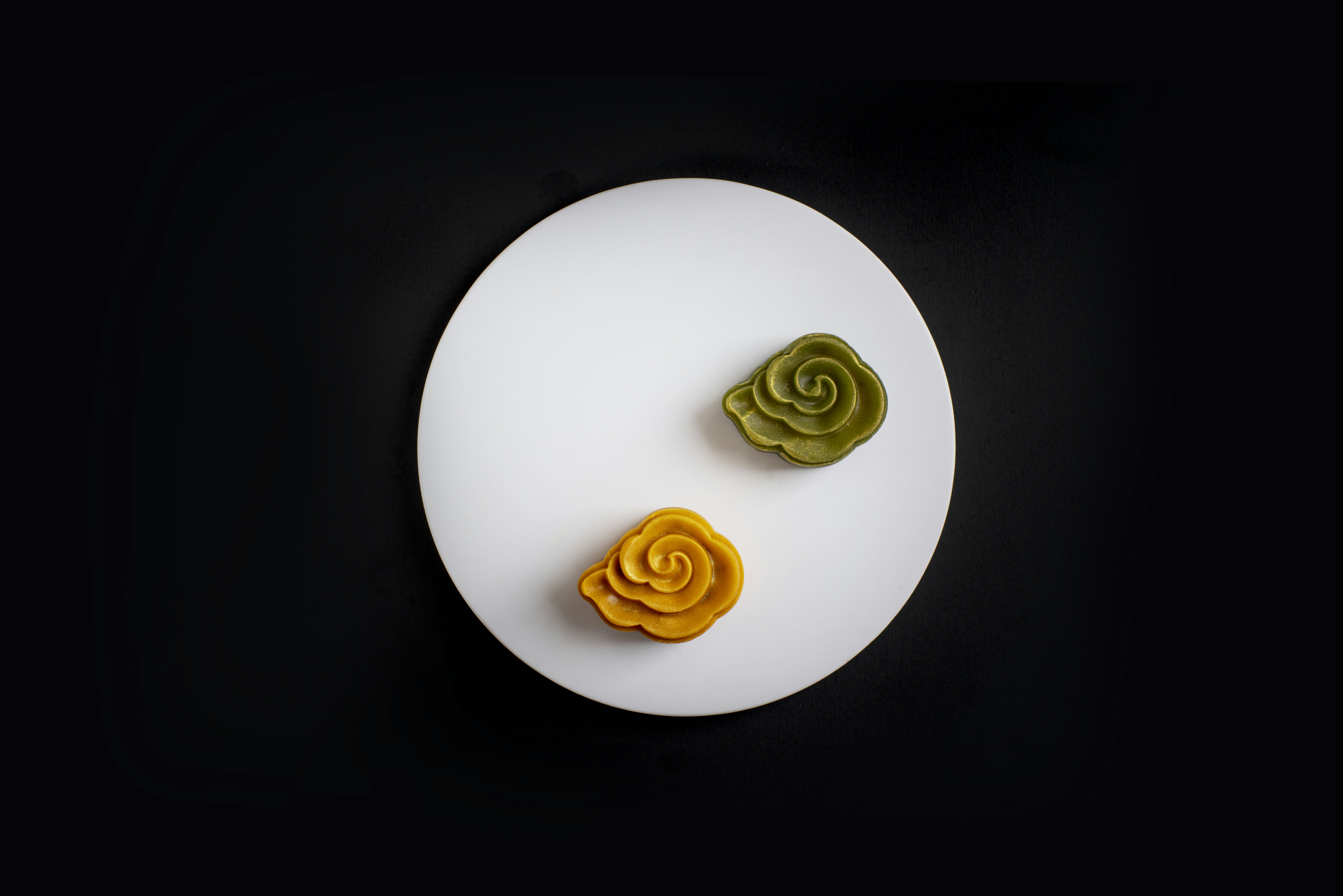 Two Colored Rosettes on a White Disk: Minimal Studio Still Life