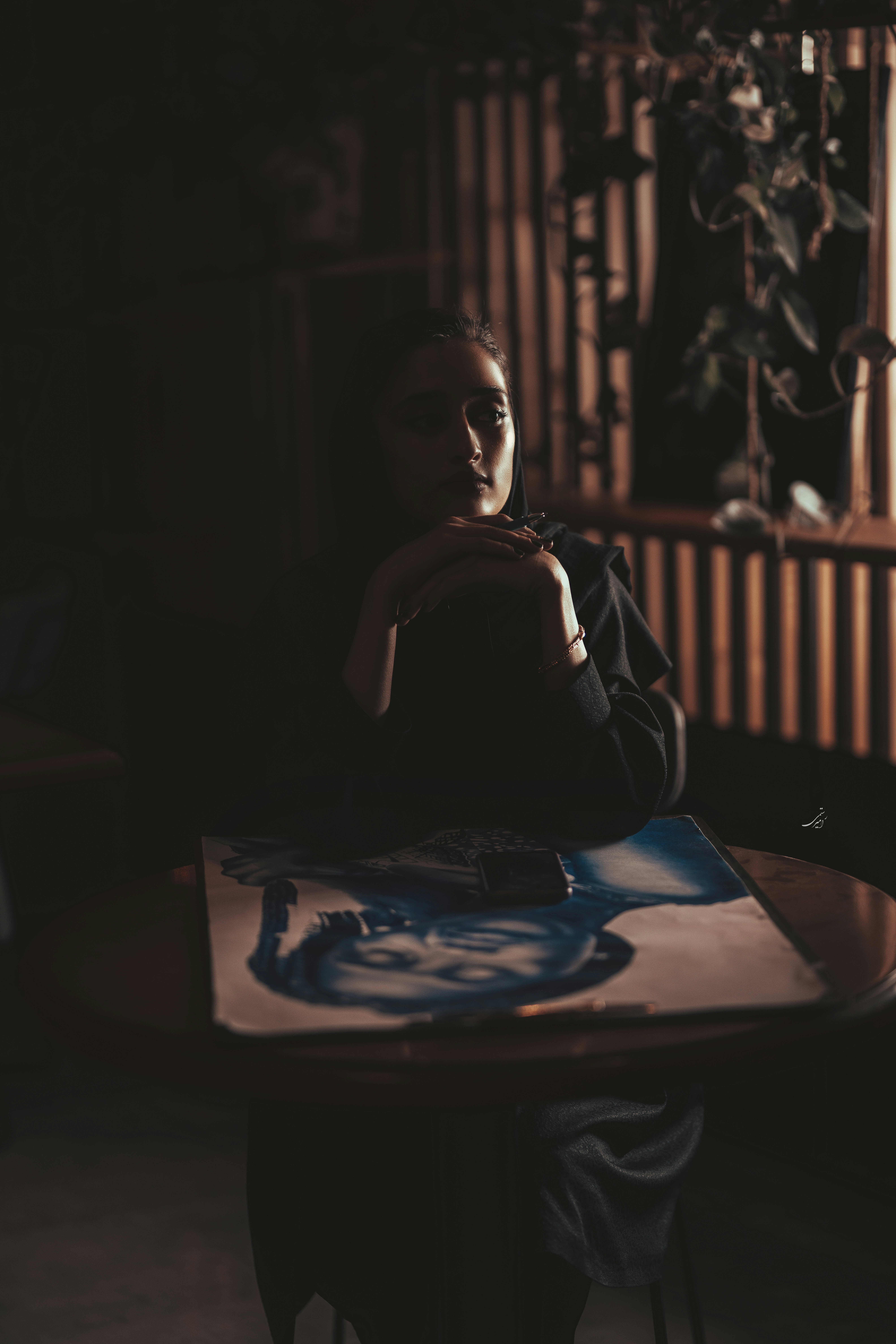 After Hours at the Table: A Subtle Portrait Embraced by Warm Shadows