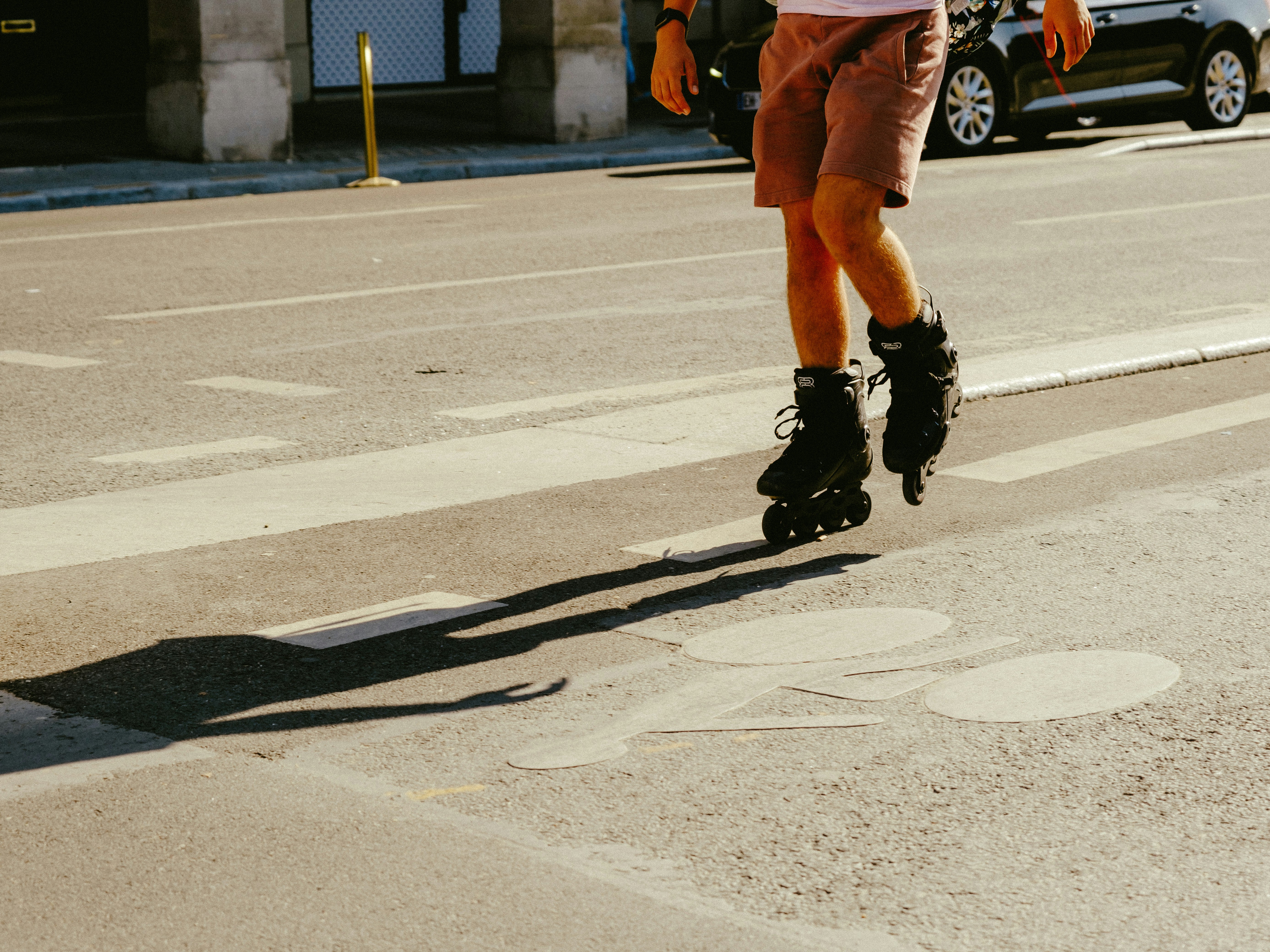 Sunlit Glide Across a Heart-Printed Crosswalk