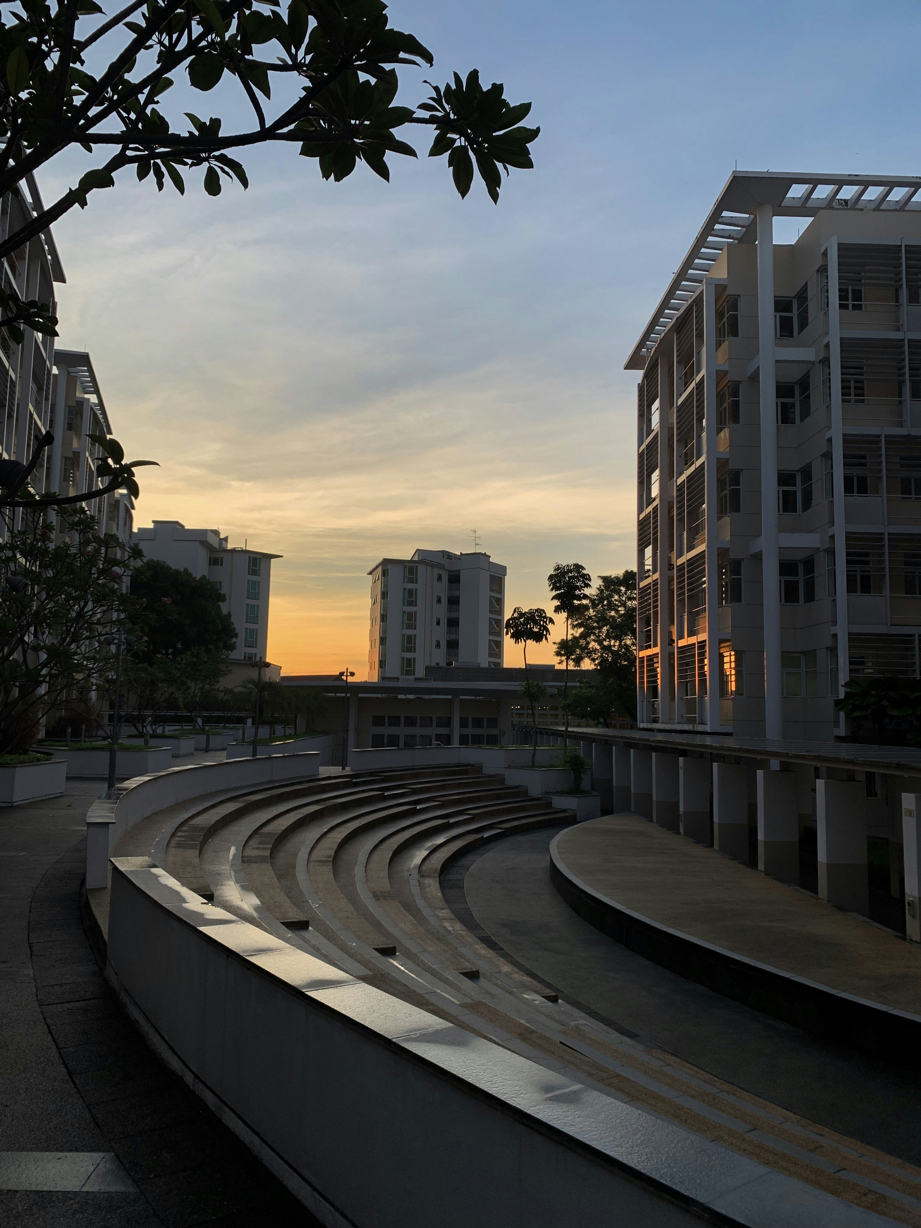 Sunset over the Crescent Amphitheater Between Modern Towers