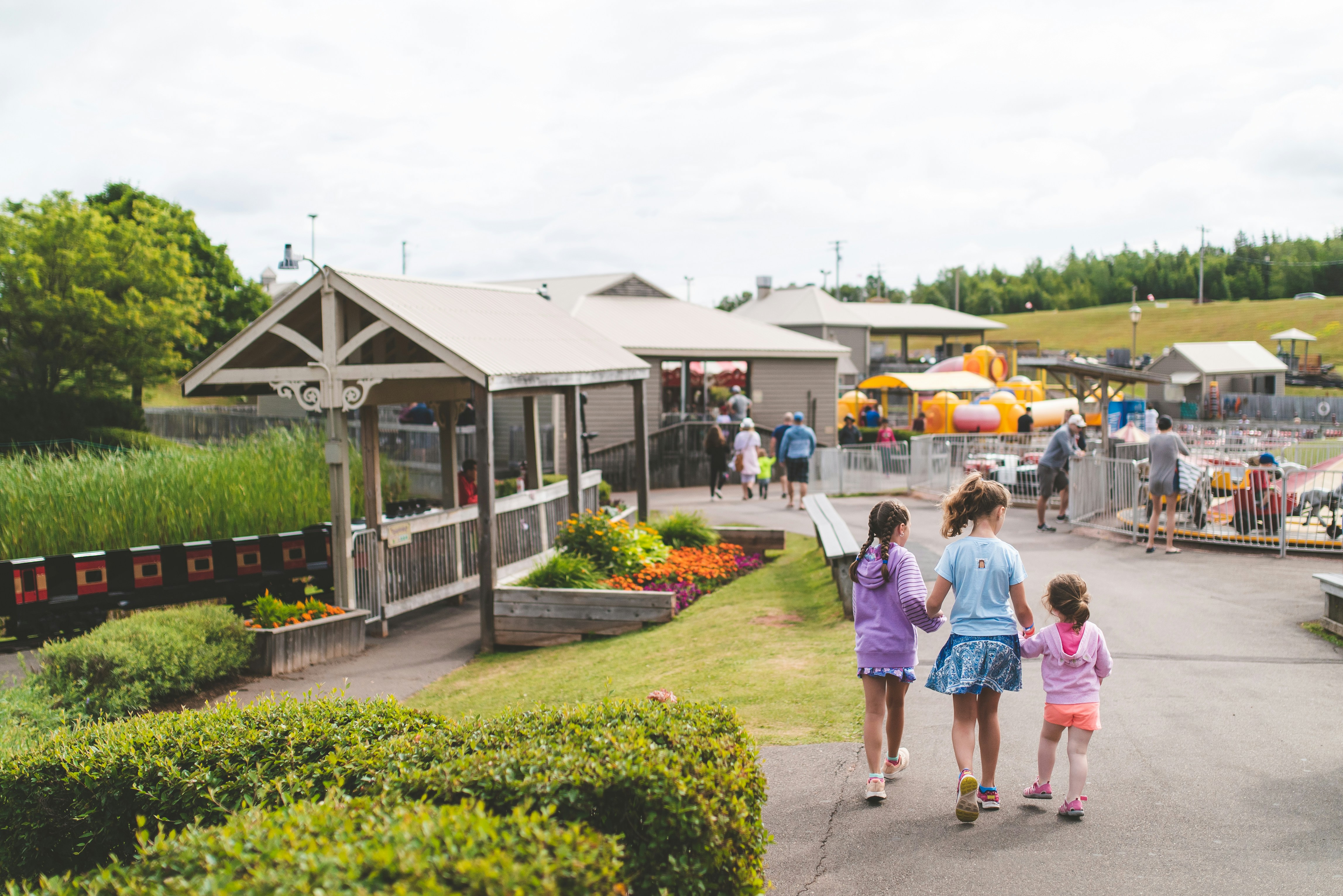 2 girls walking on pathway near green grass field during daytime photo ...