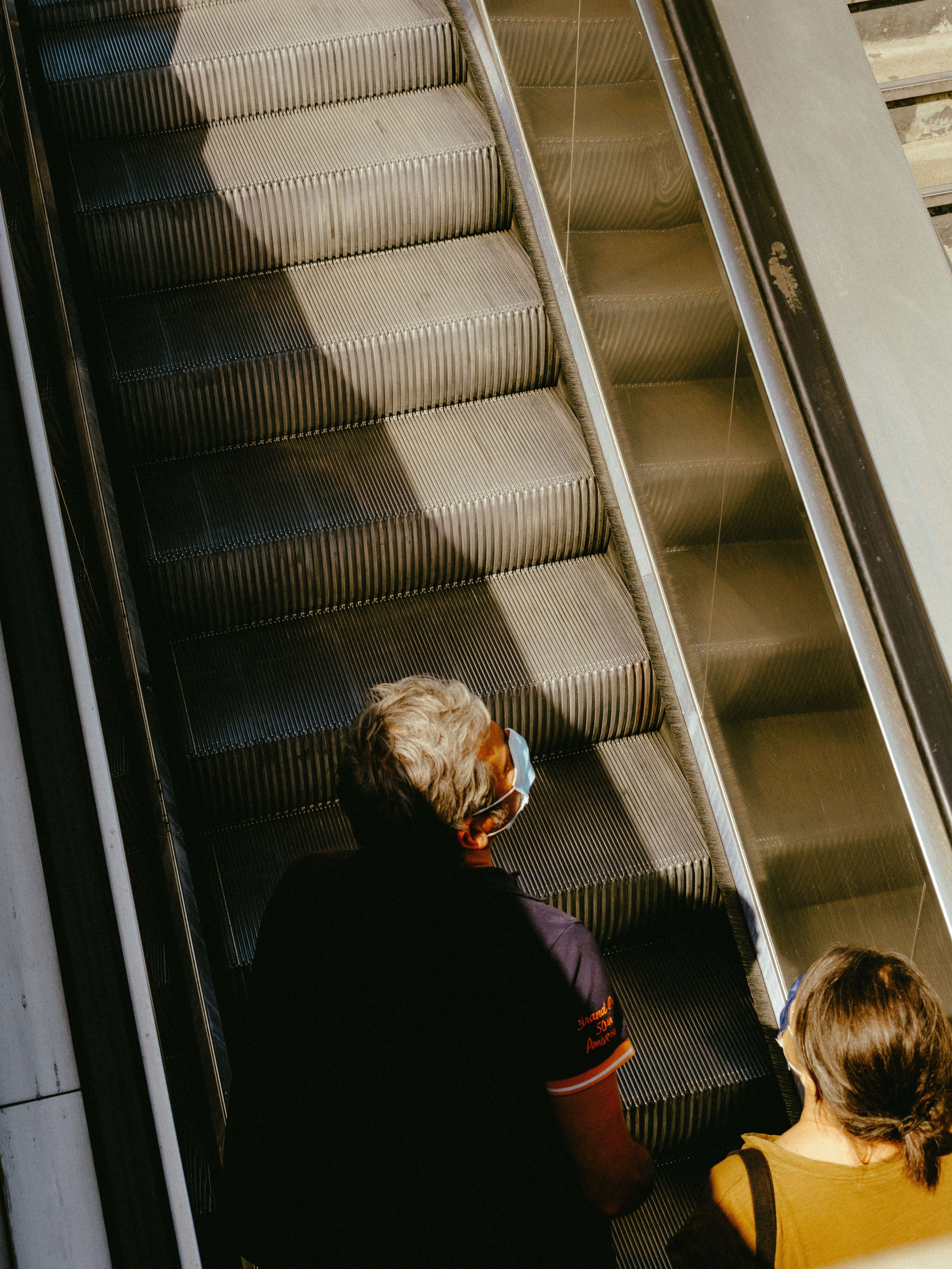 Man in black jacket standing on escalator photo – Free Human Image on ...
