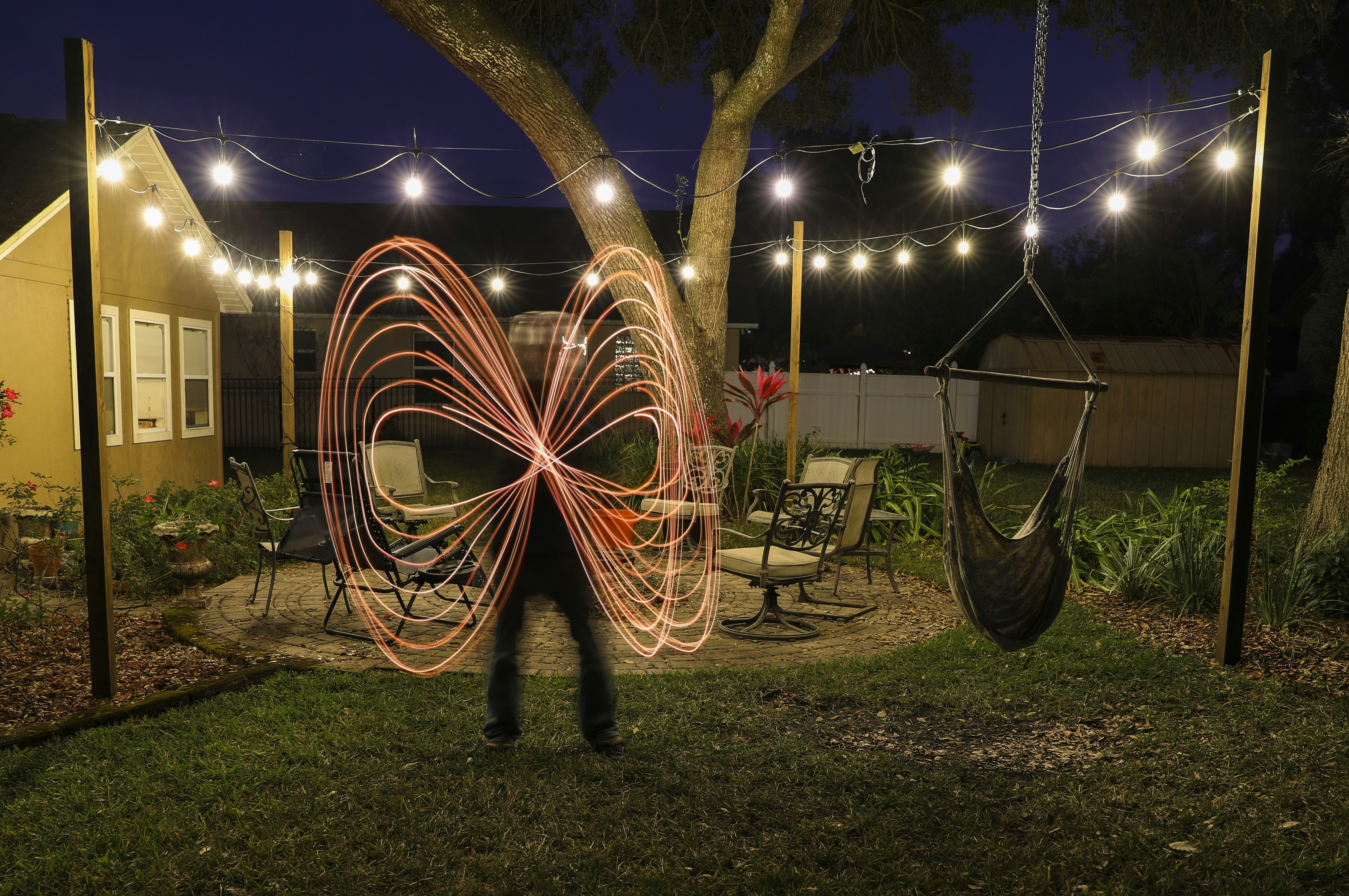 Light Trails over a Night Backyard: The Spin of a Holiday Person