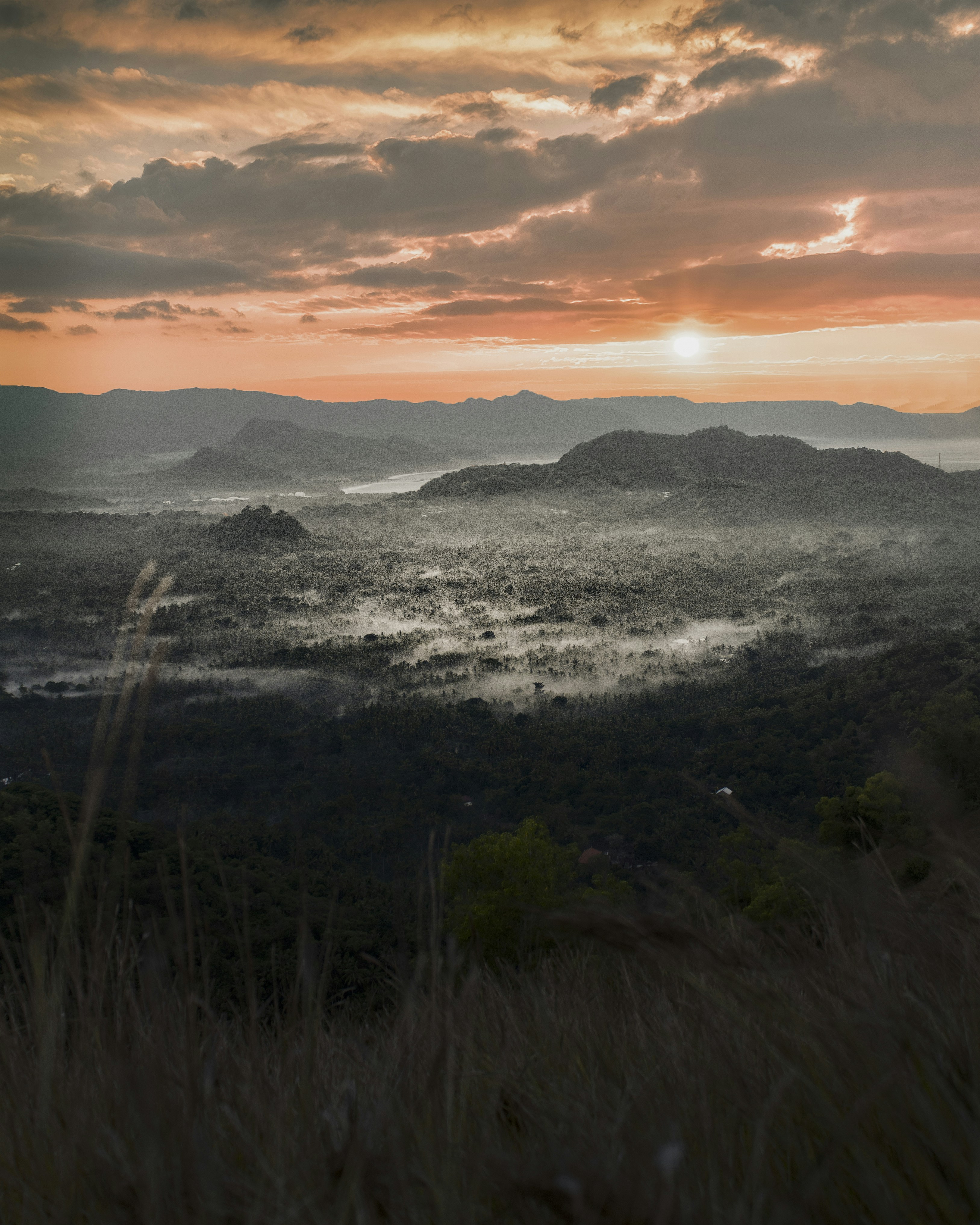 Sunset over Mist-Laced Hills: A Quiet Horizon