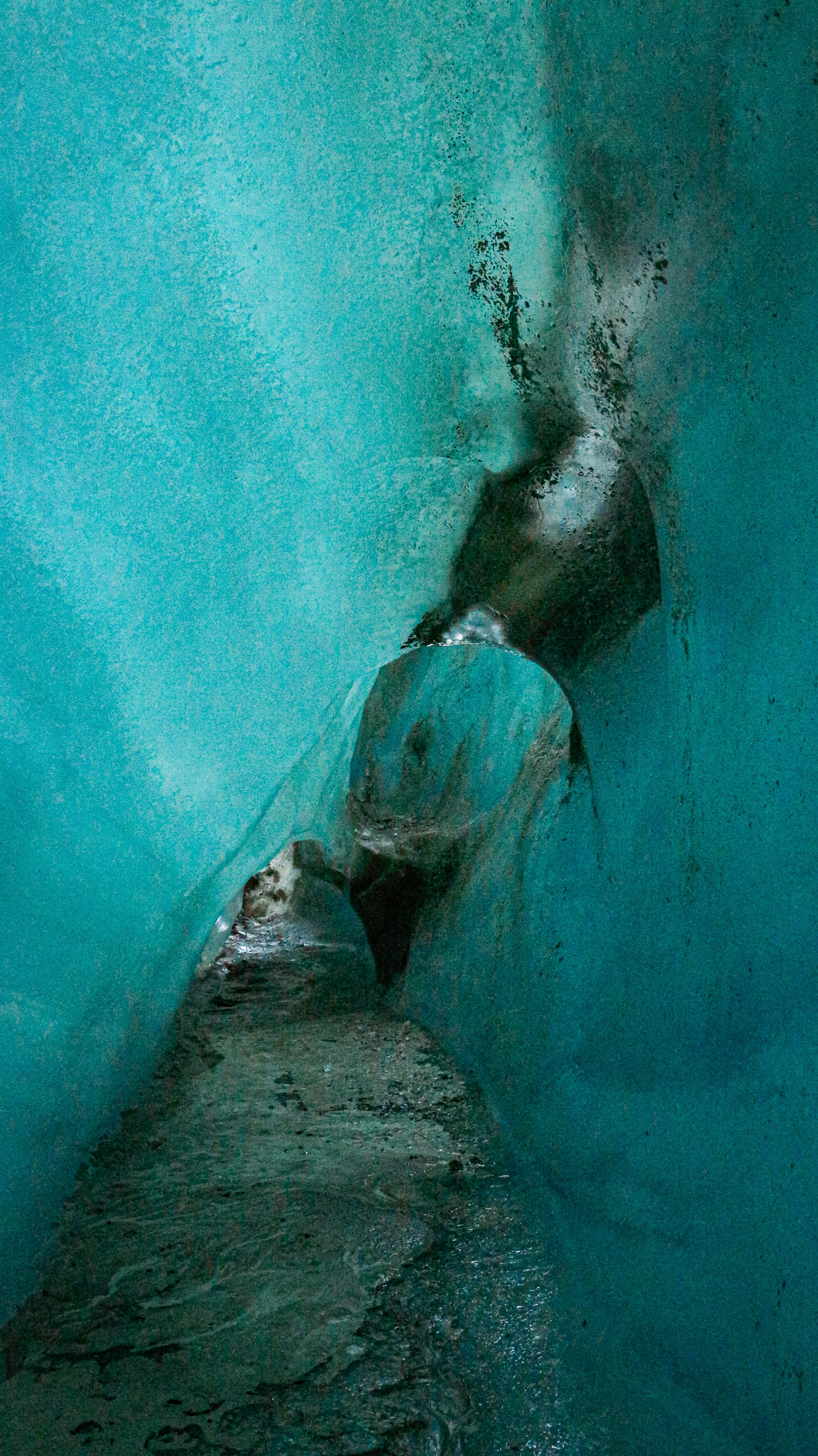 Turquoise Grotto: A Narrow Blue-Walled Passage with a Curved Portal