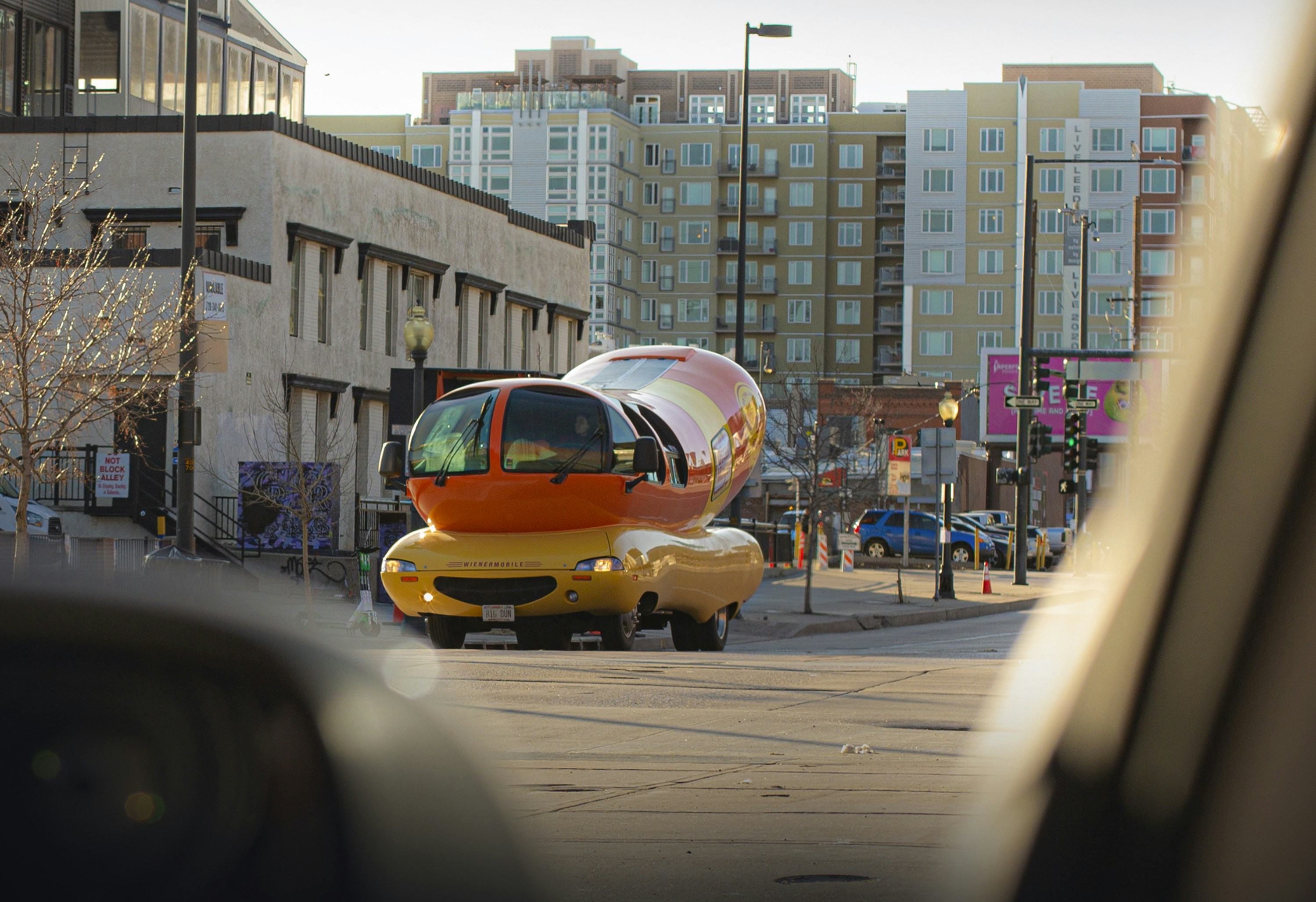 Colorful Capsule Bus Parks Amid Contemporary City Blocks
