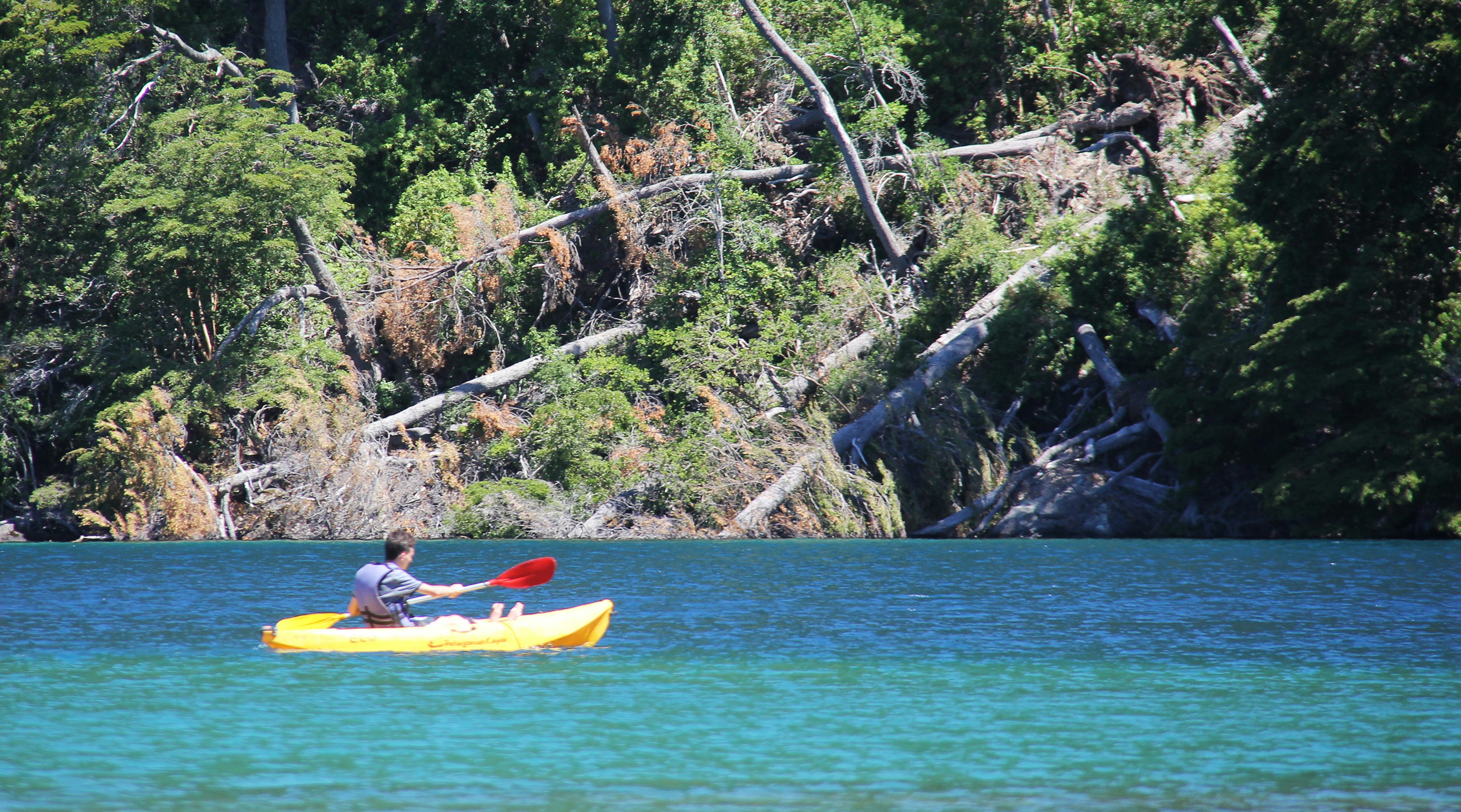 2 people riding on red kayak on body of water during daytime photo ...