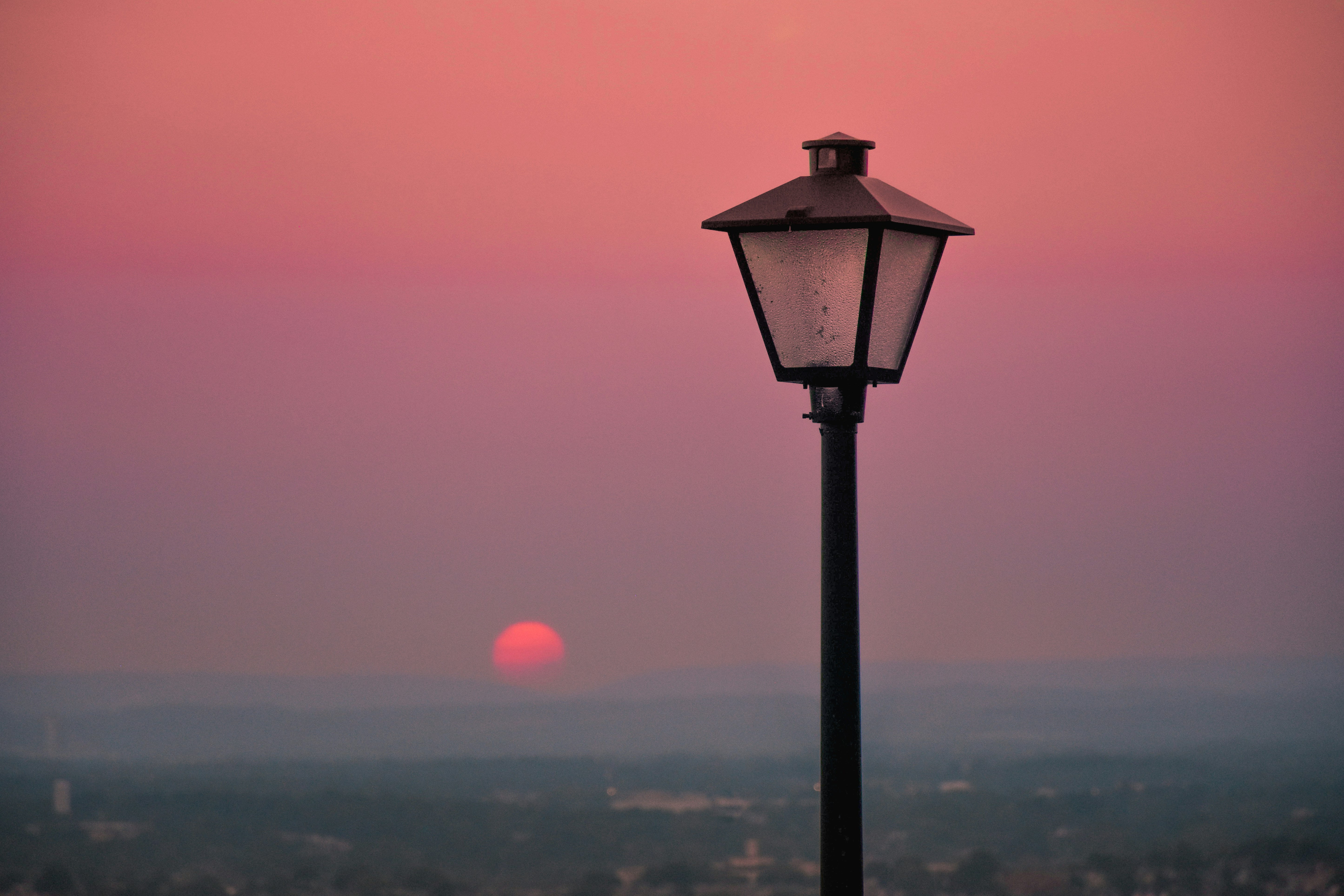 black and white street lamp during sunset