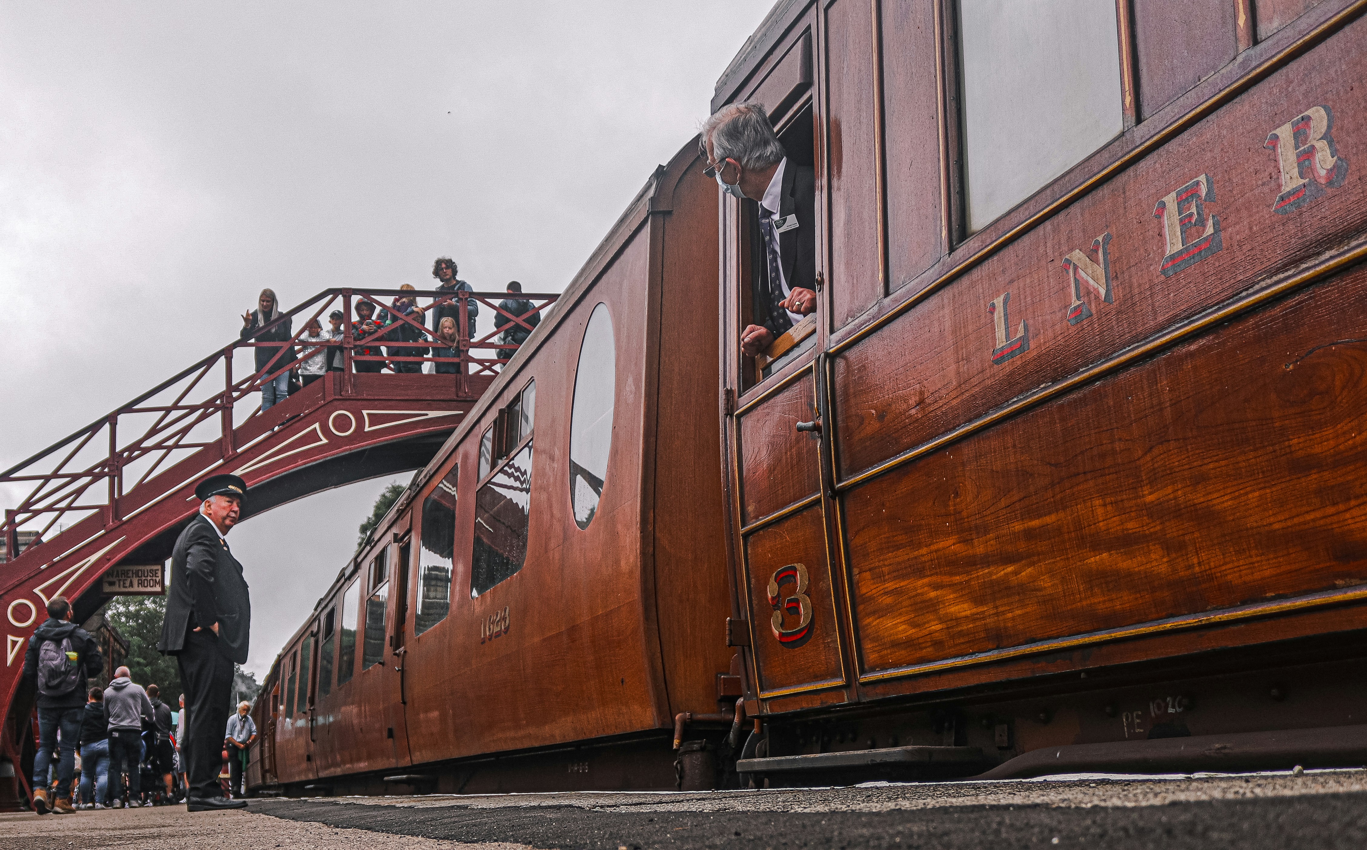 Window Watcher on a LNER Wooden Car as a Platform Brims with Onlookers