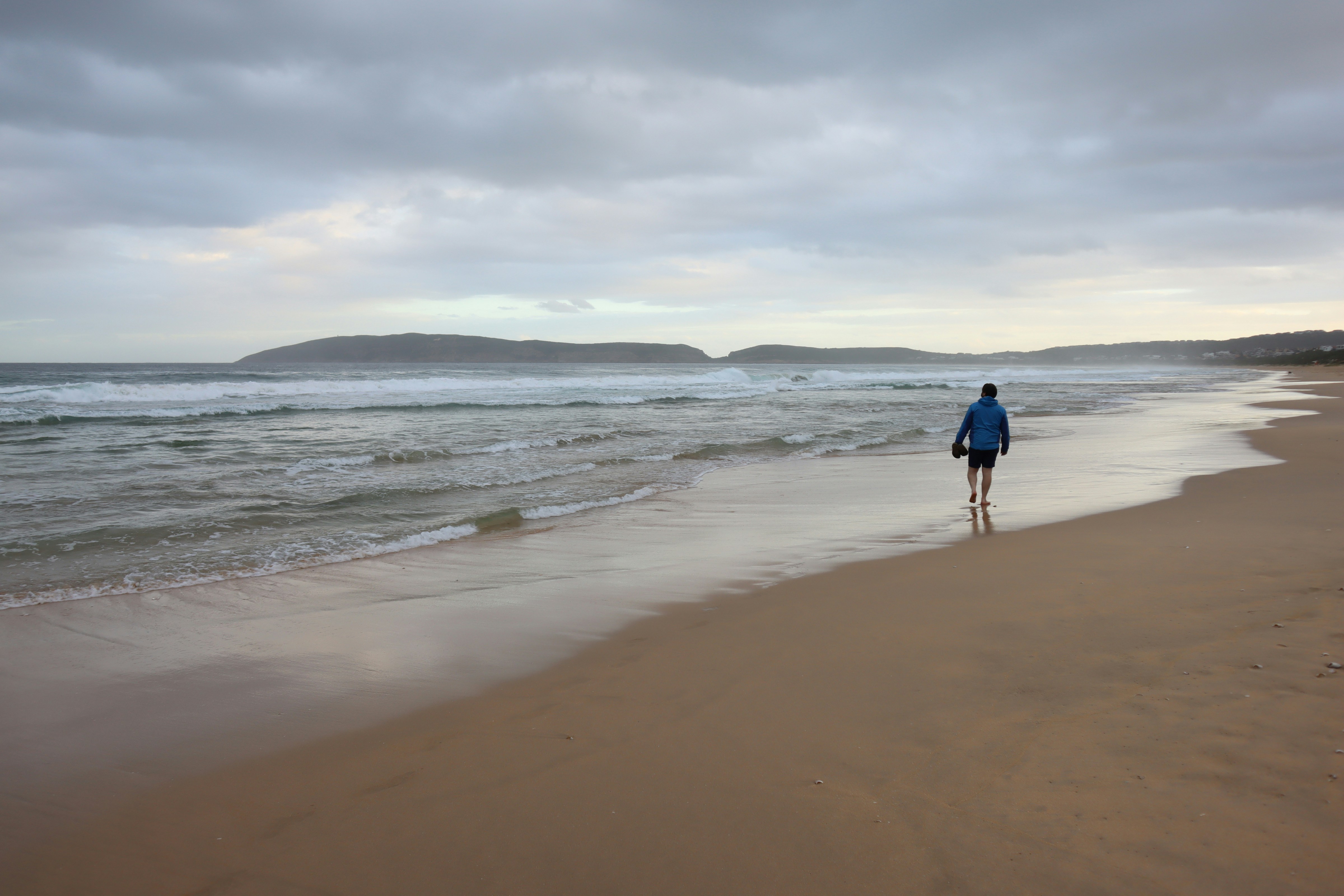 Solitary Stroll on a Tranquil Shoreline