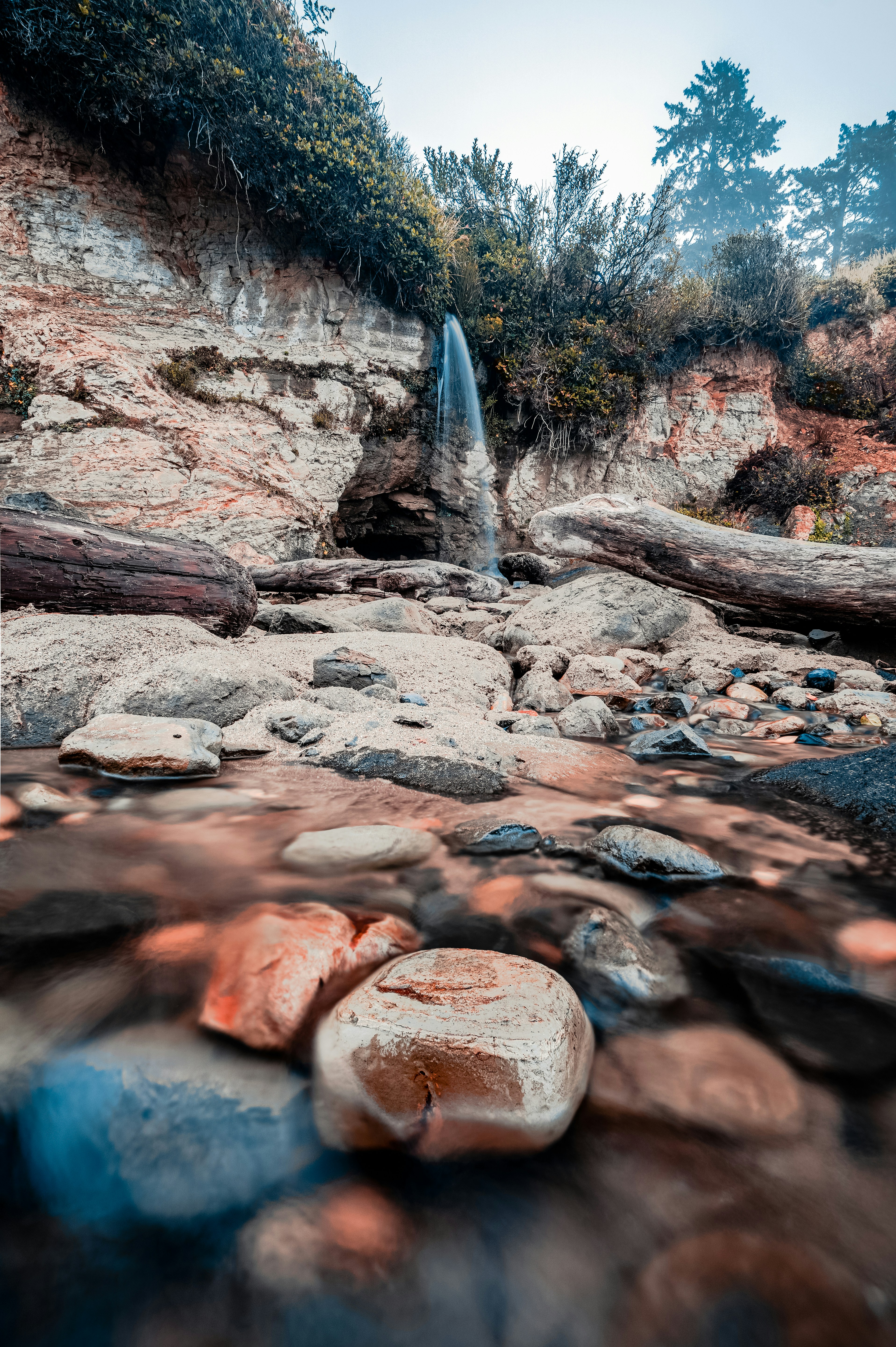 Cliffside Veil: A Narrow Waterfall Over Weathered Stones