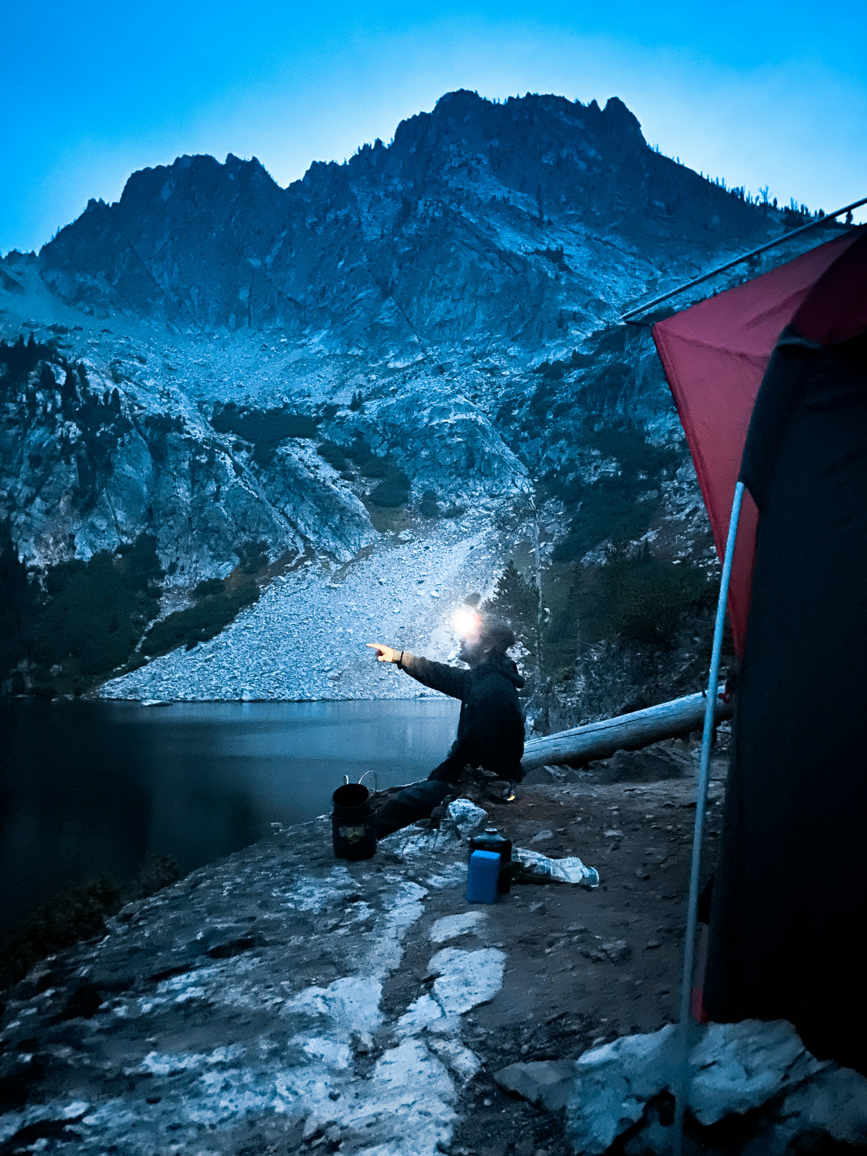 Night by the Tarn: A Lone Angler Illuminates the Mountain Lake
