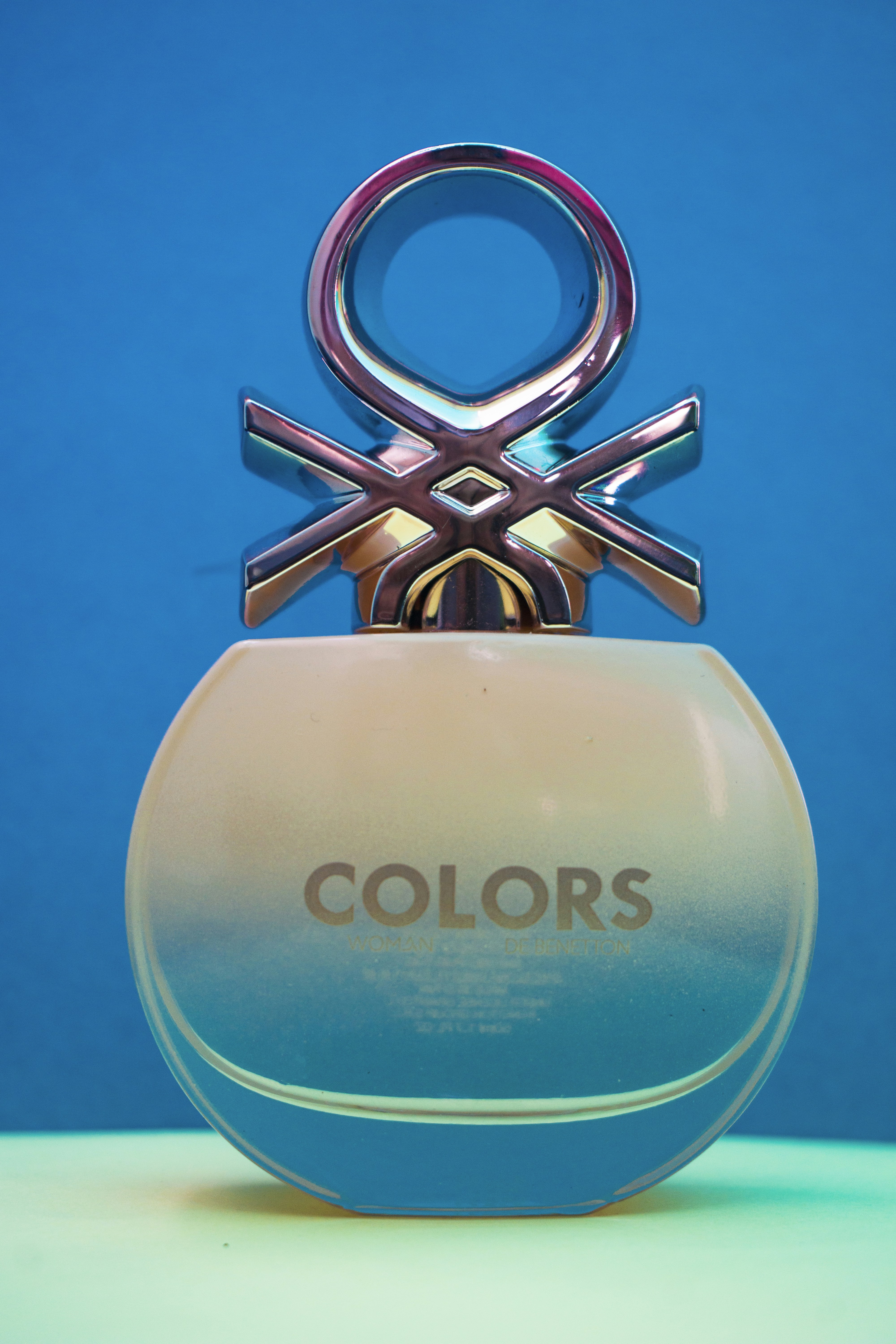 Chrome Crest Over a Neon Colors Capsule Against Electric Blue