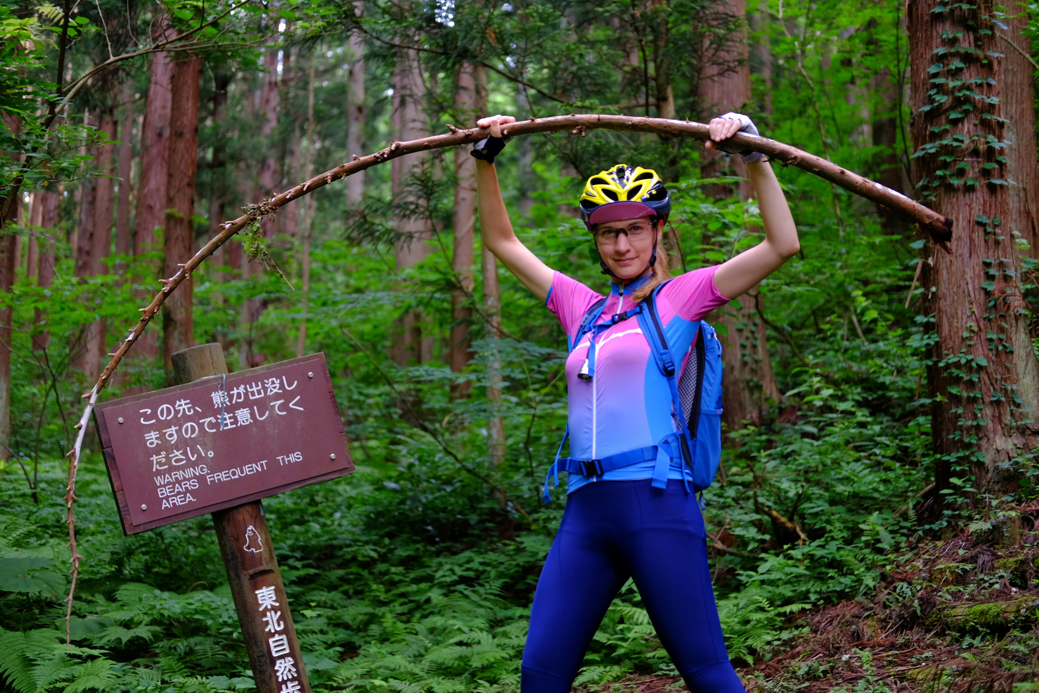 Forest Arc: A Runner Lifts a Living Branch Banner Amid Green Corridors