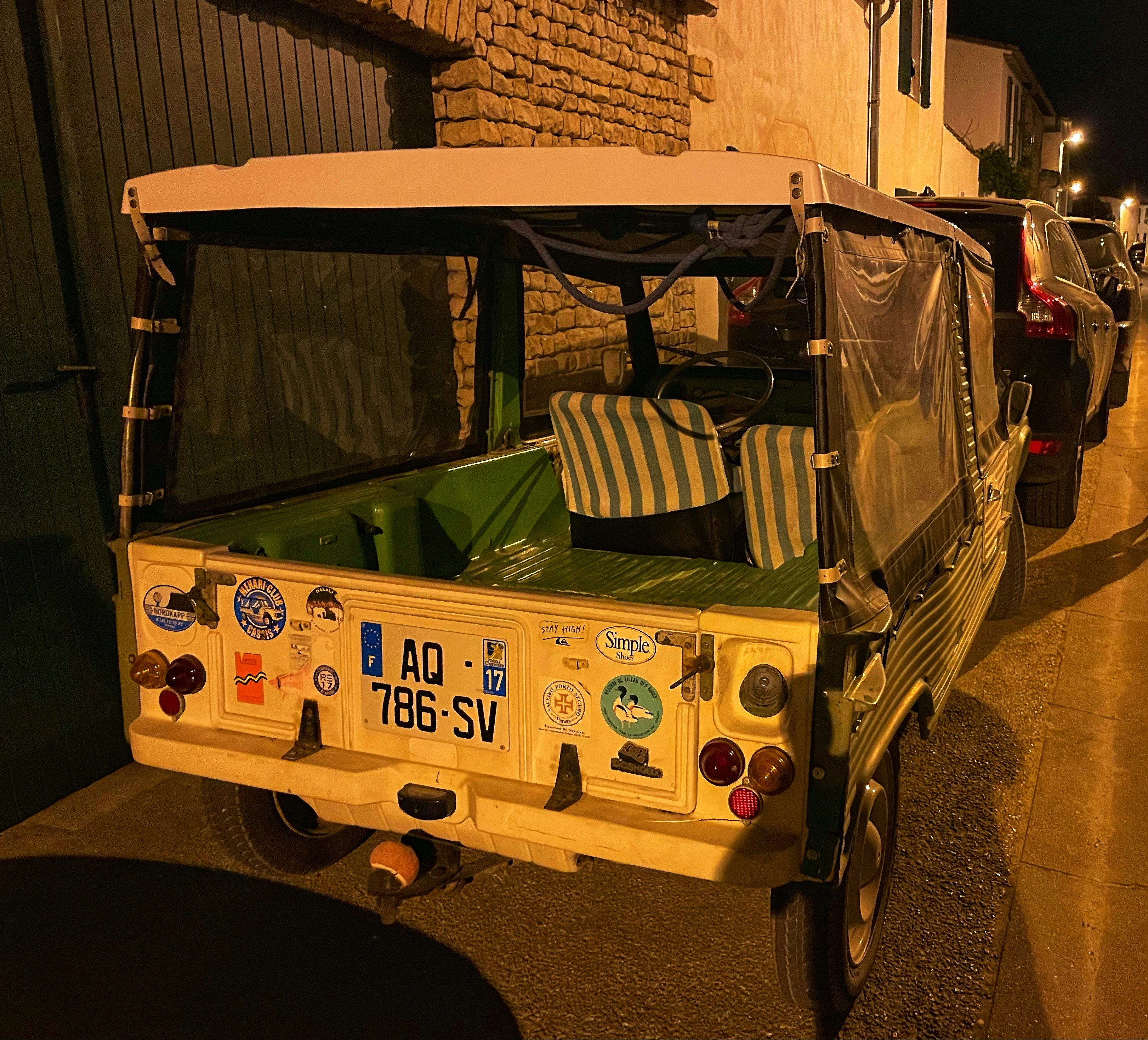 Evening Tranquility: A Patinaed Tuk-Tuk Resting by a Cobblestone Wall