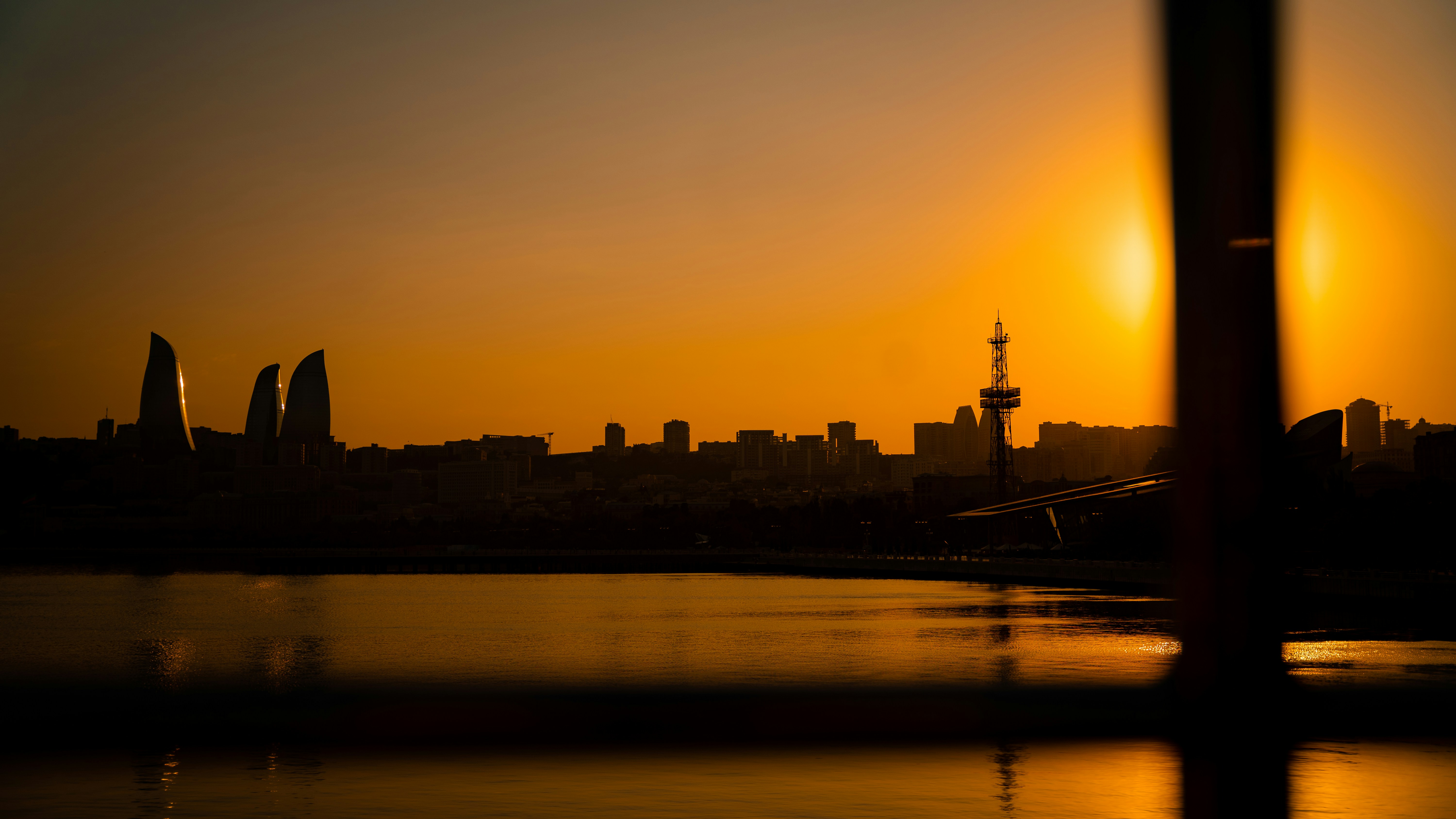 Ember Skyline Over the River: Dusk Silhouette of a Modern City